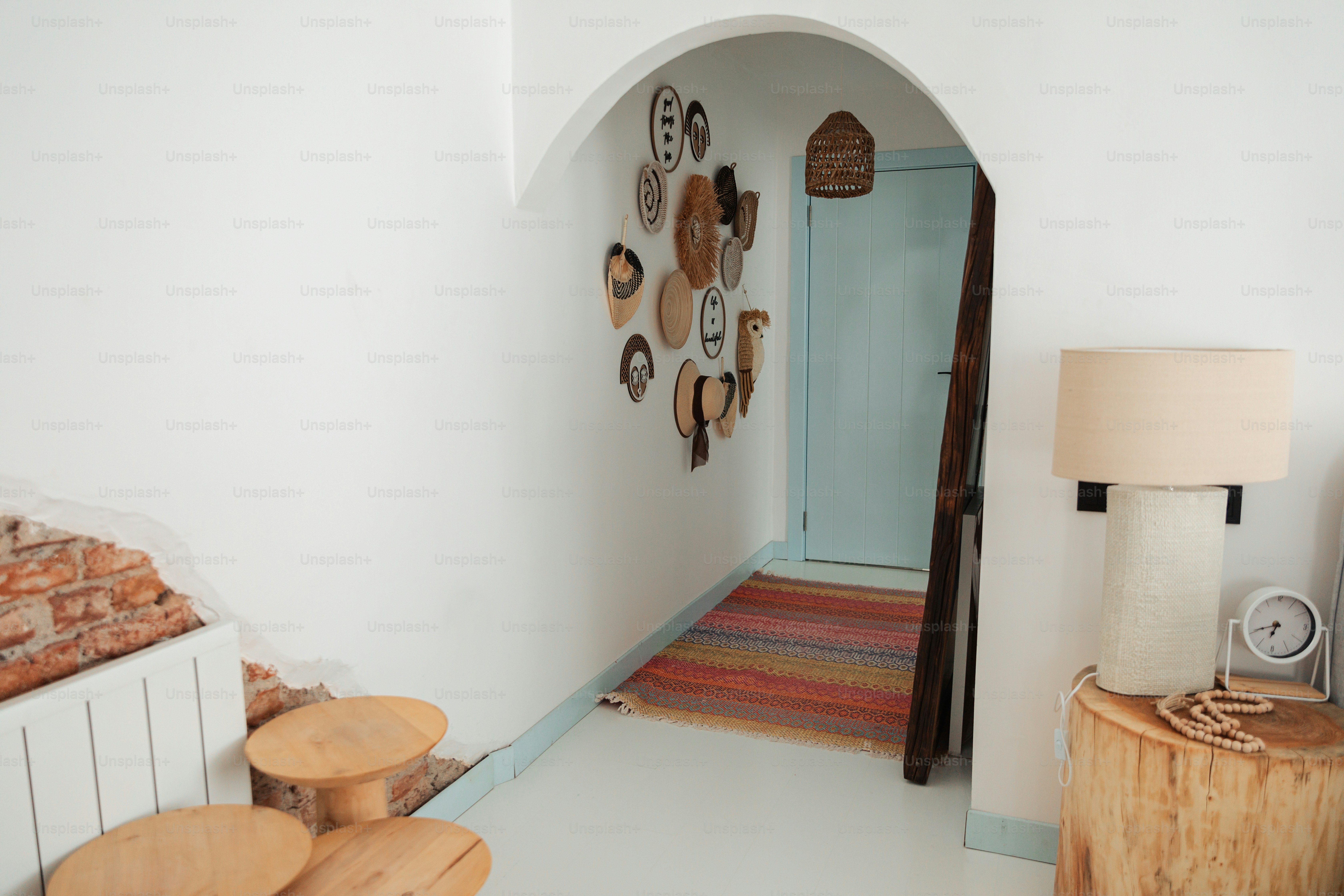 A hallway with a blue door and several hats on the wall photo ...