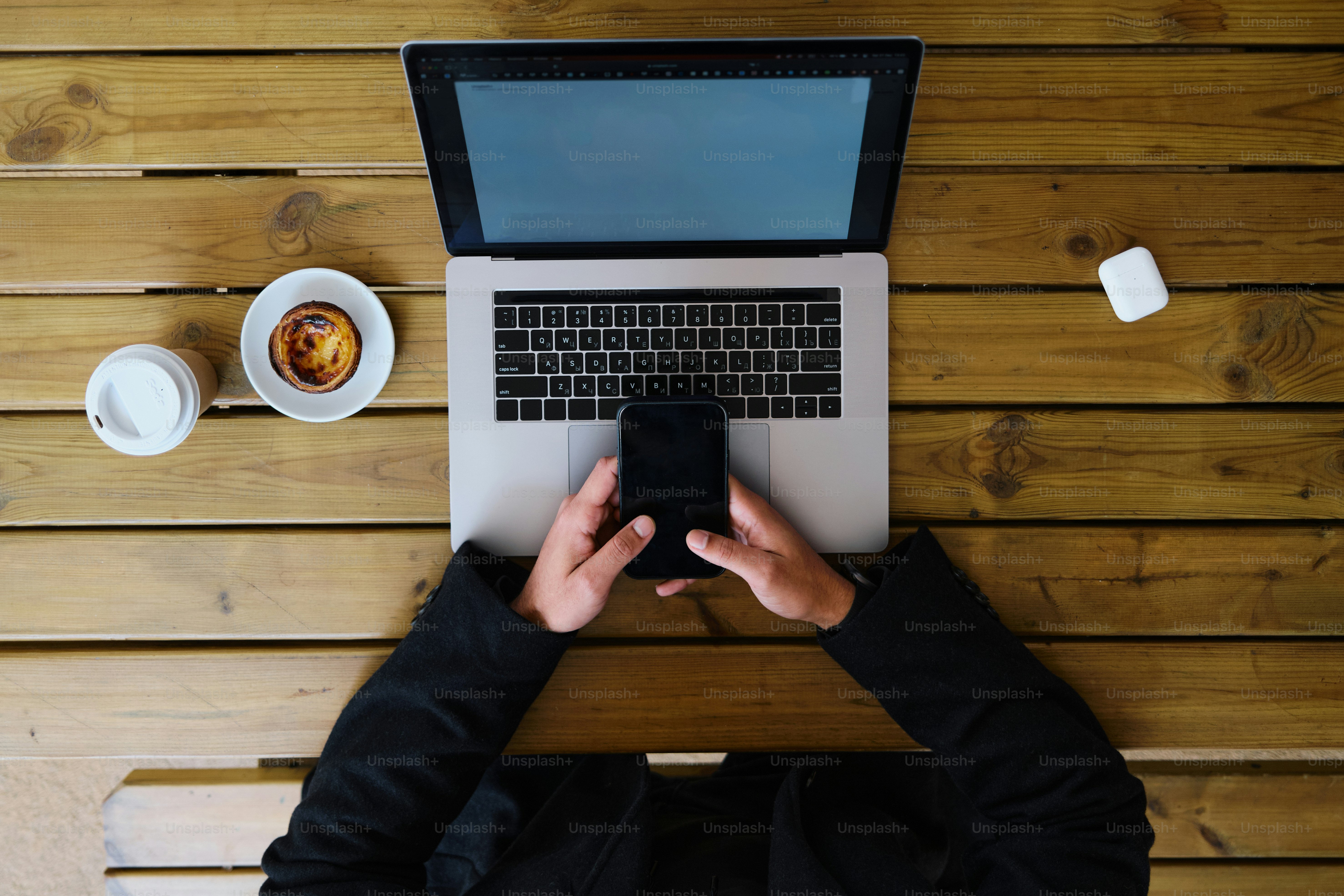 A person using a laptop on a wooden table photo – Online interview ...