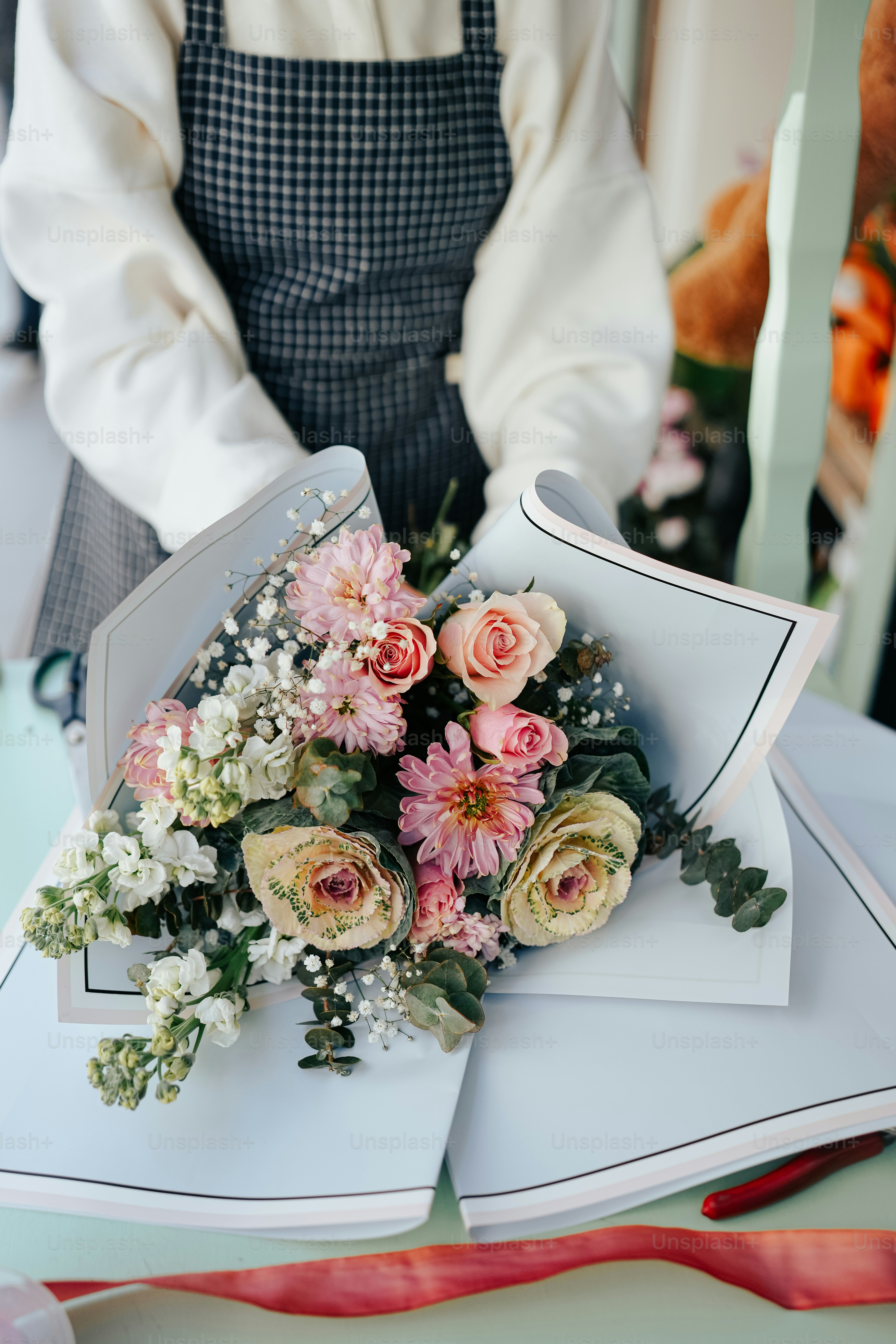 A woman holding a bouquet of red roses photo – Florist Image on Unsplash