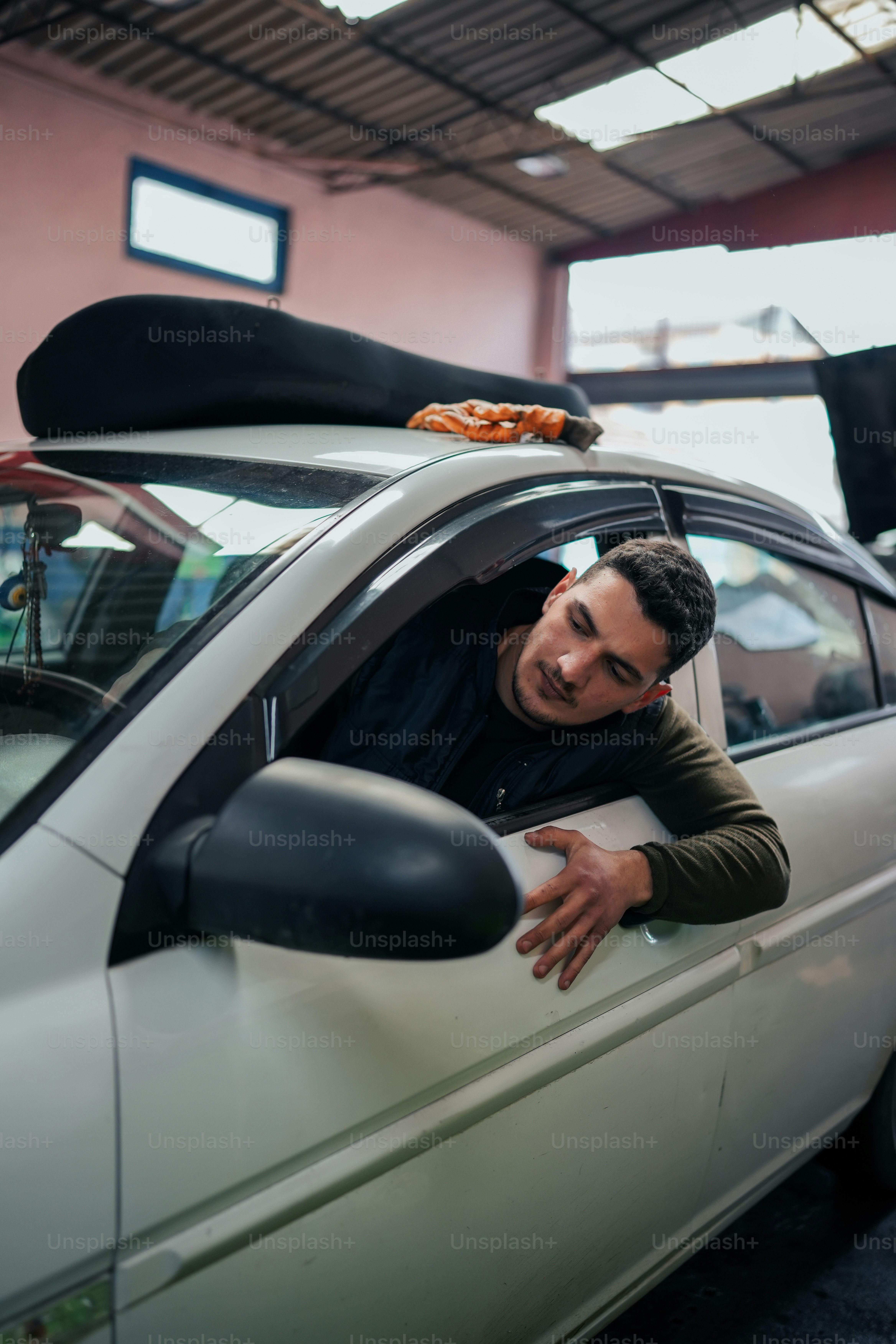A man leaning out the window of a car photo – Man Image on Unsplash