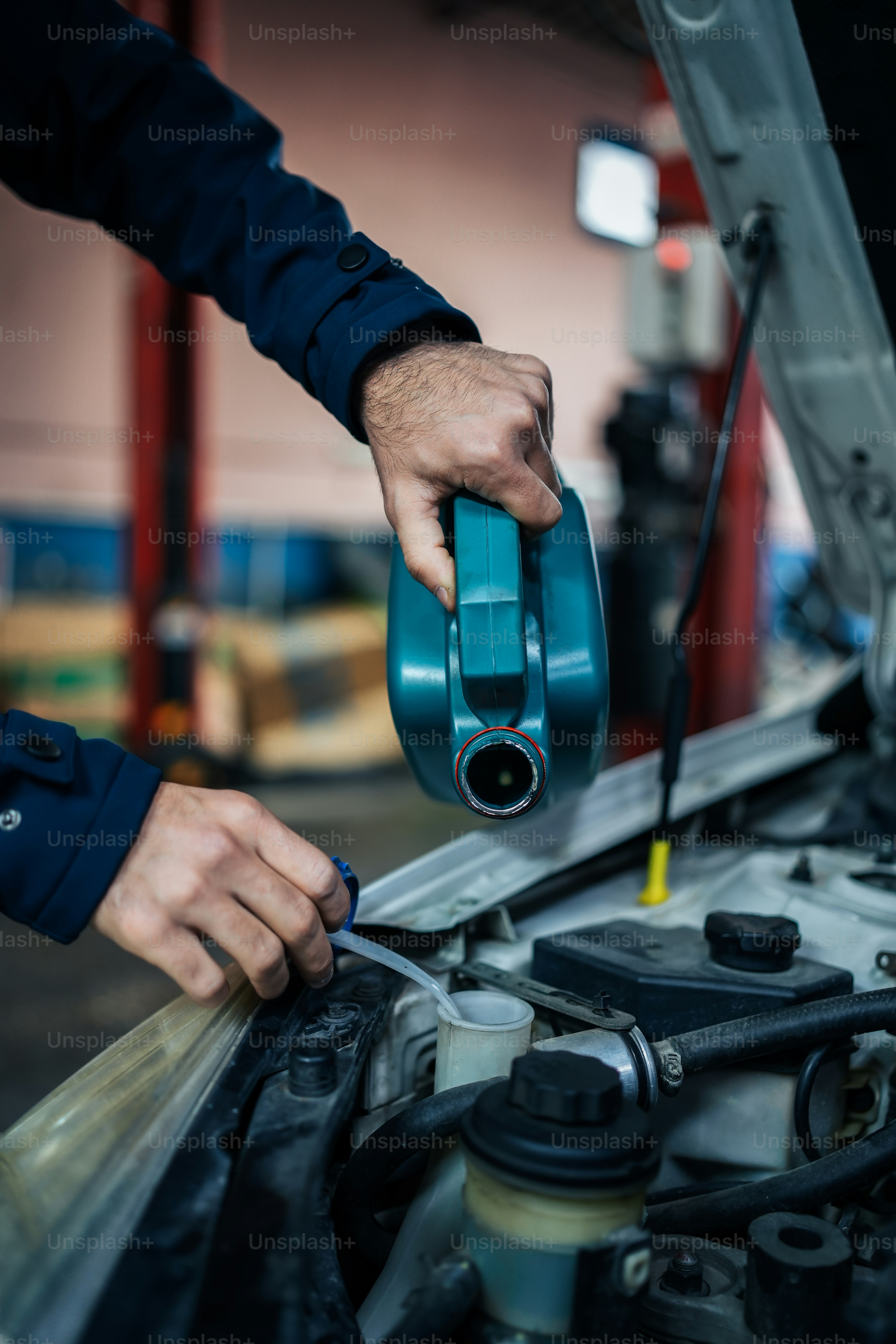 A man working on a car in a garage photo – Car Image on Unsplash