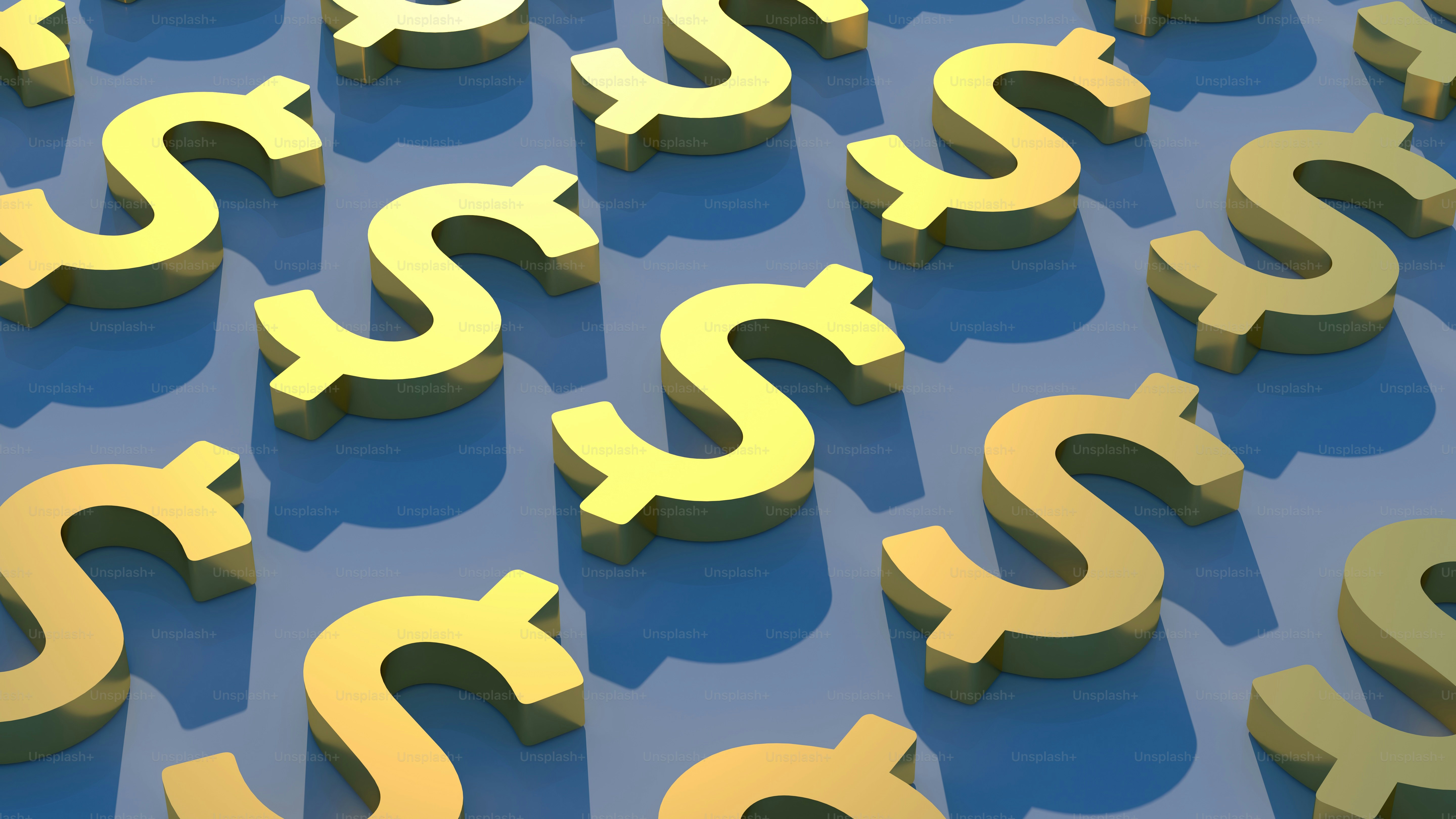 A group of gold dollar signs sitting on top of a blue surface photo ...
