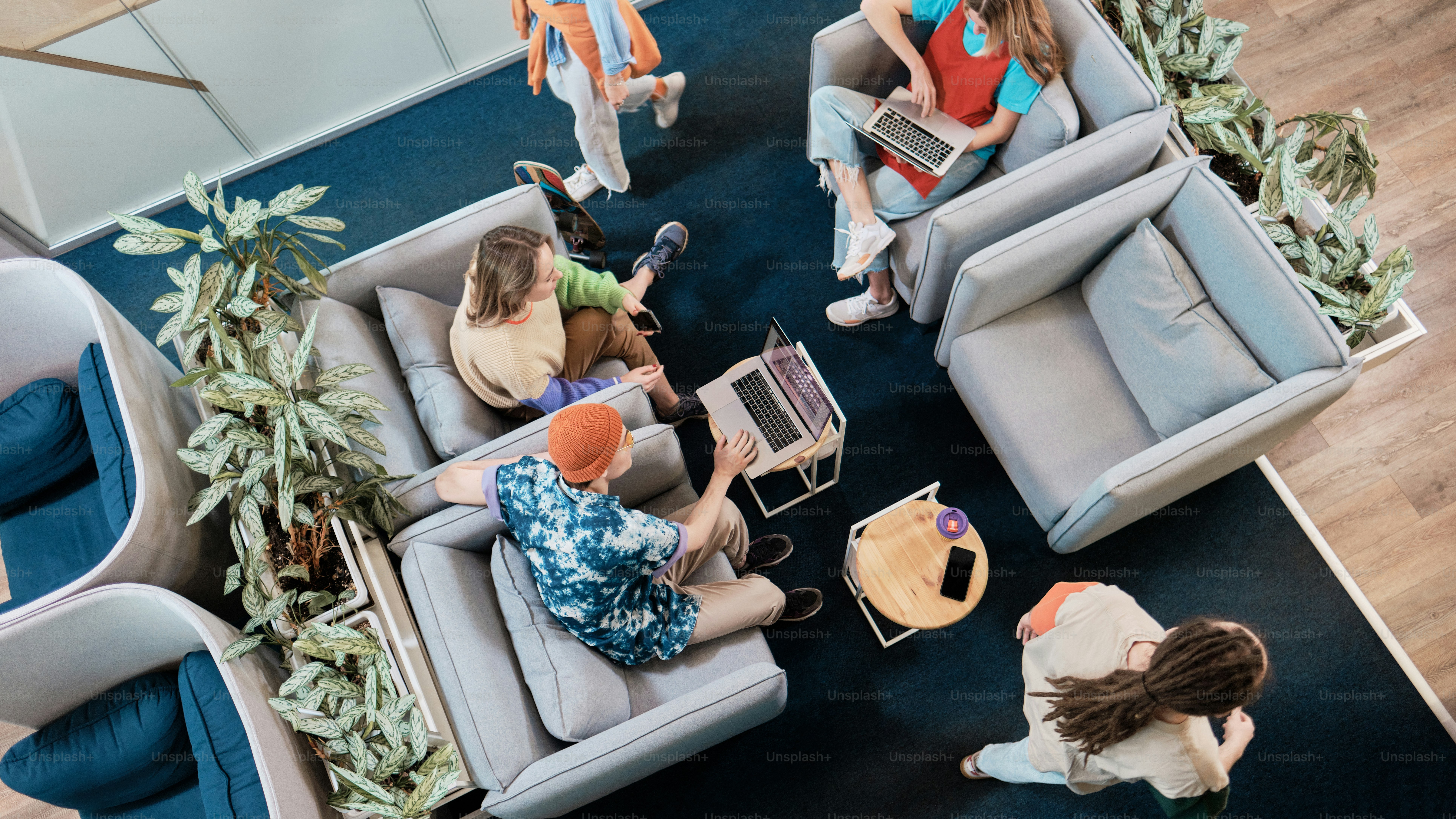 A group of people sitting in cubicles in an office photo – Meeting room ...
