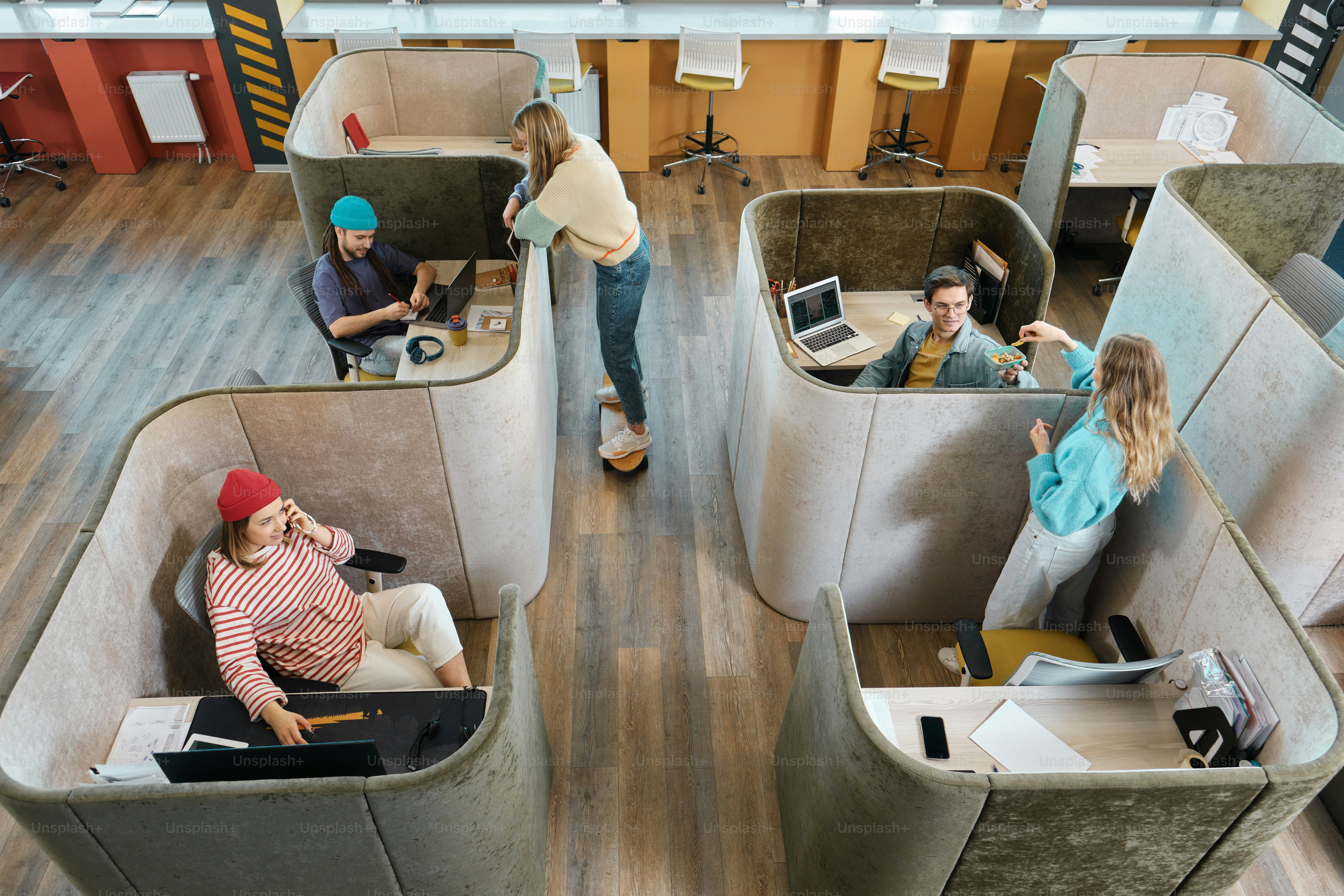 A group of people sitting in cubicles in an office photo – Meeting room ...