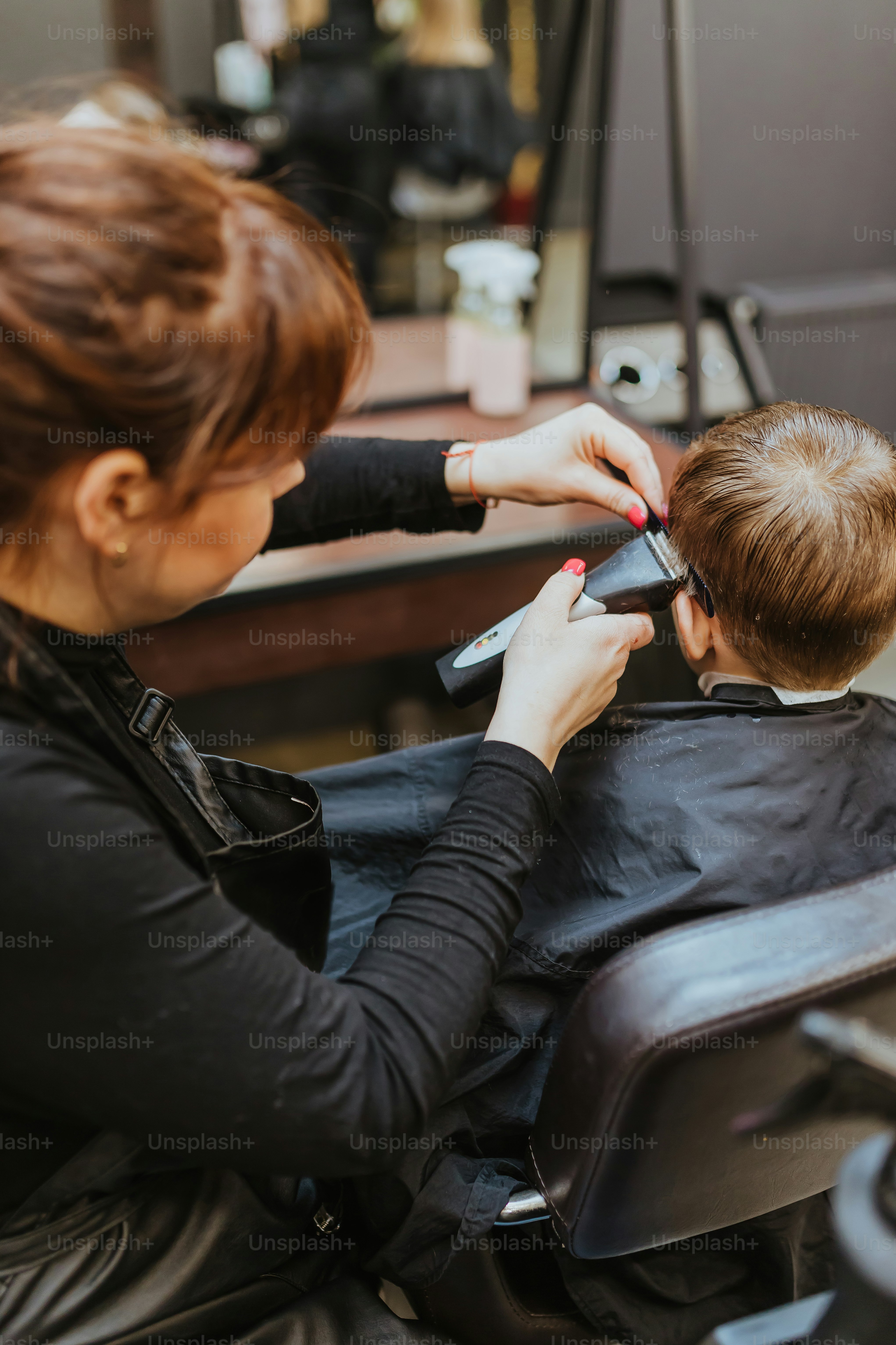 A woman cutting a man's hair with scissors photo – Hairdresser Image on ...