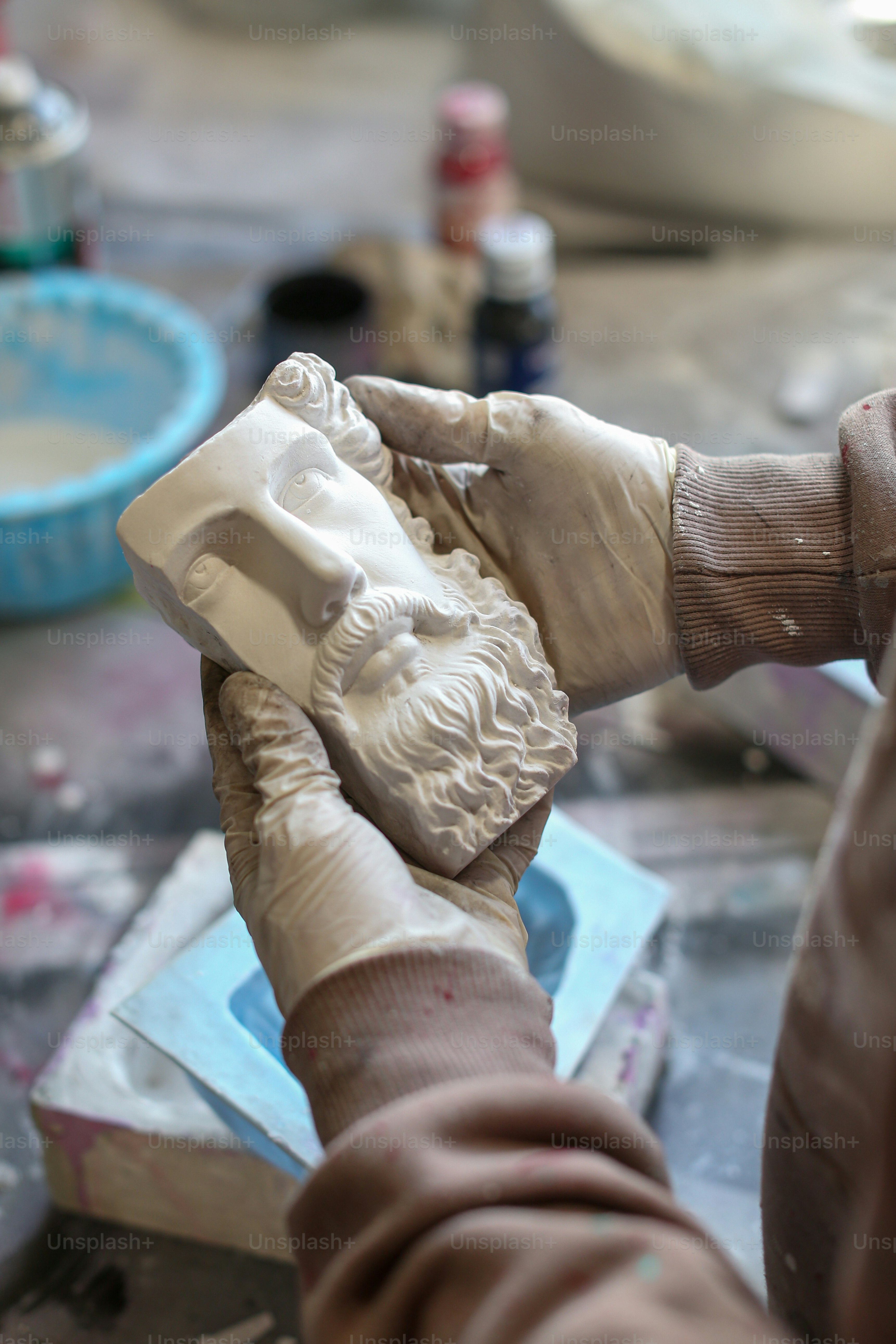 A statue of a man with a beard is being sculpted photo – Art Image on ...