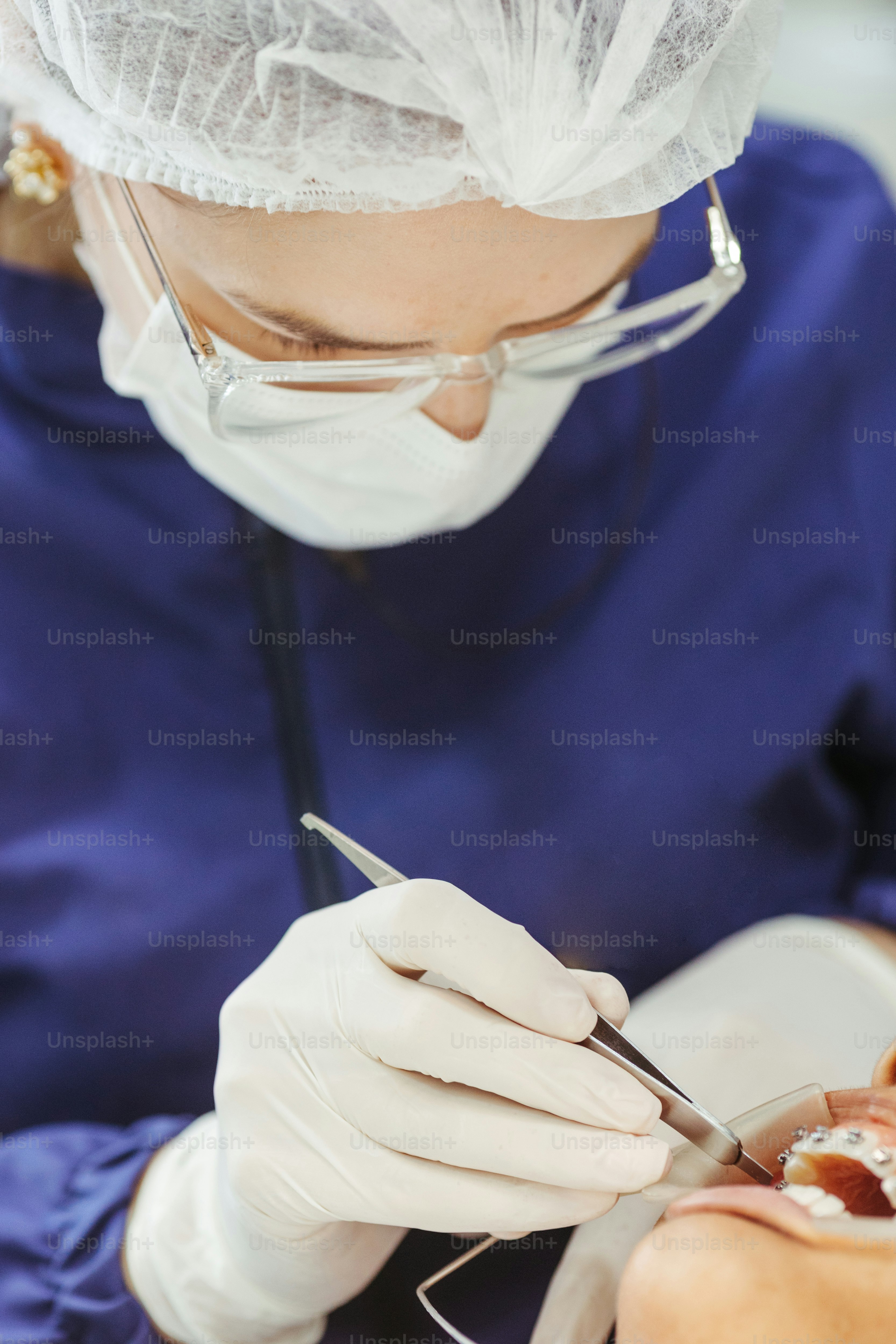 A woman getting her teeth checked by a dentist photo – Professional ...