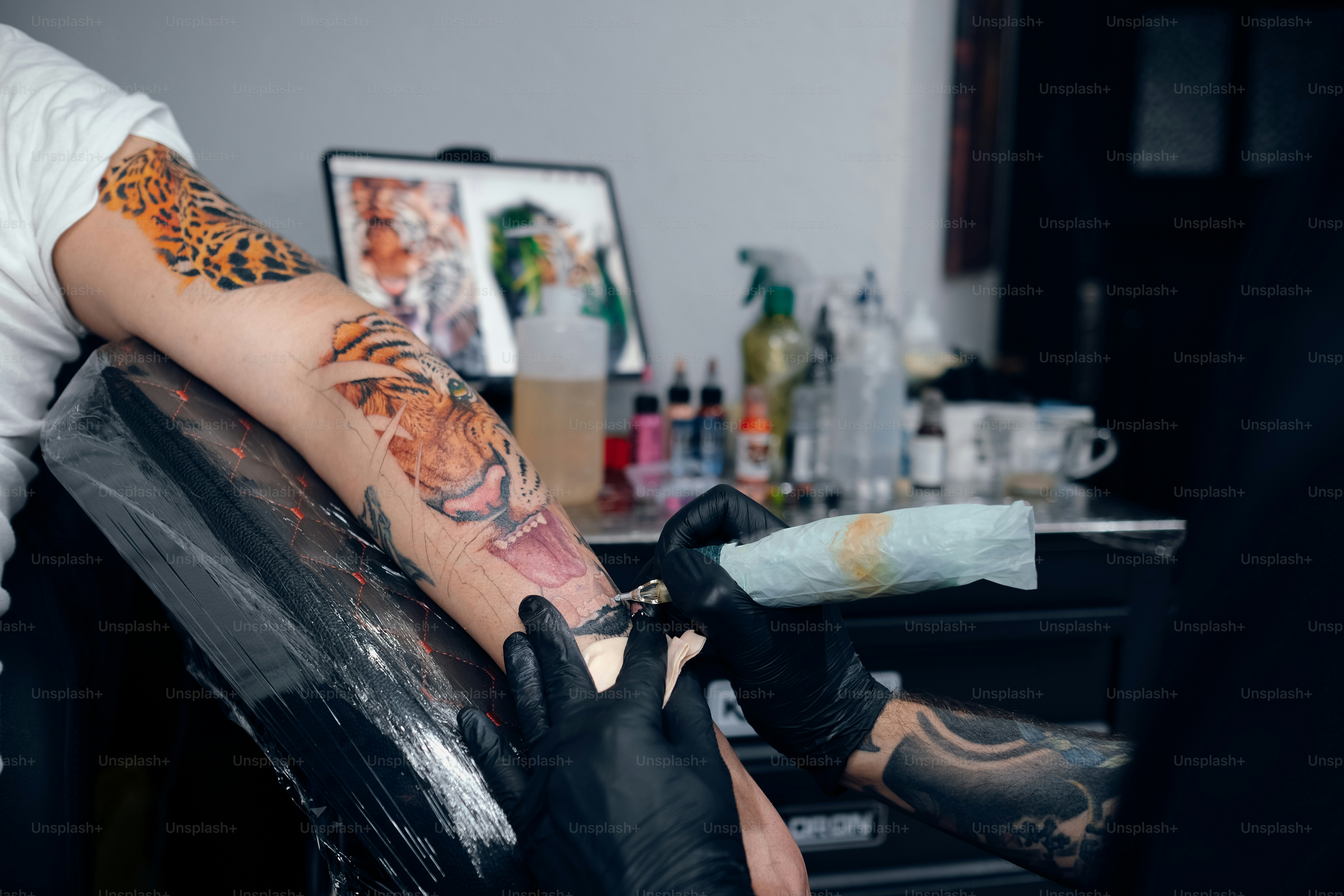 A man getting a tattoo on his arm photo – Professional Image on Unsplash