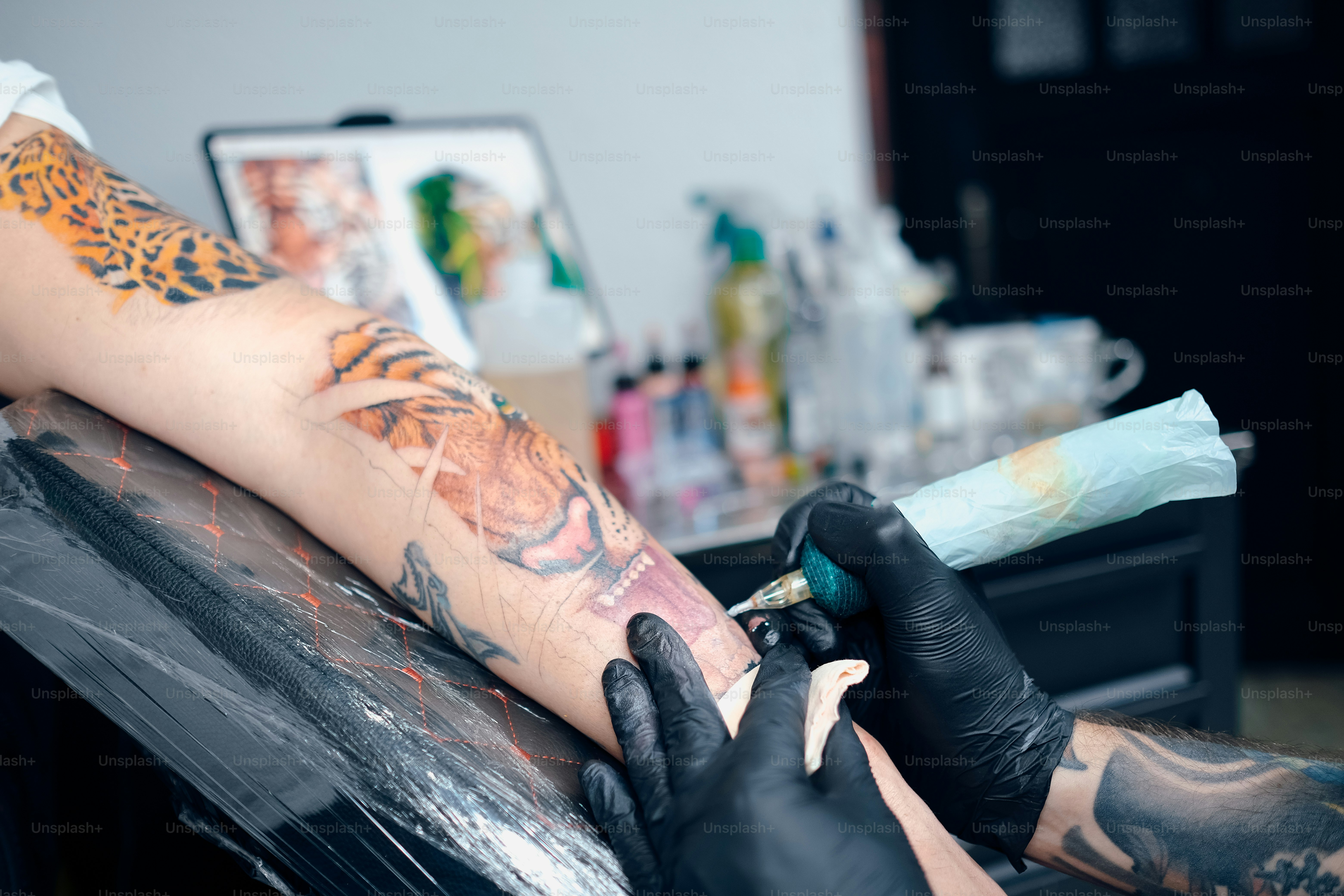 A person getting a tattoo done on their arm photo – Body art Image on ...