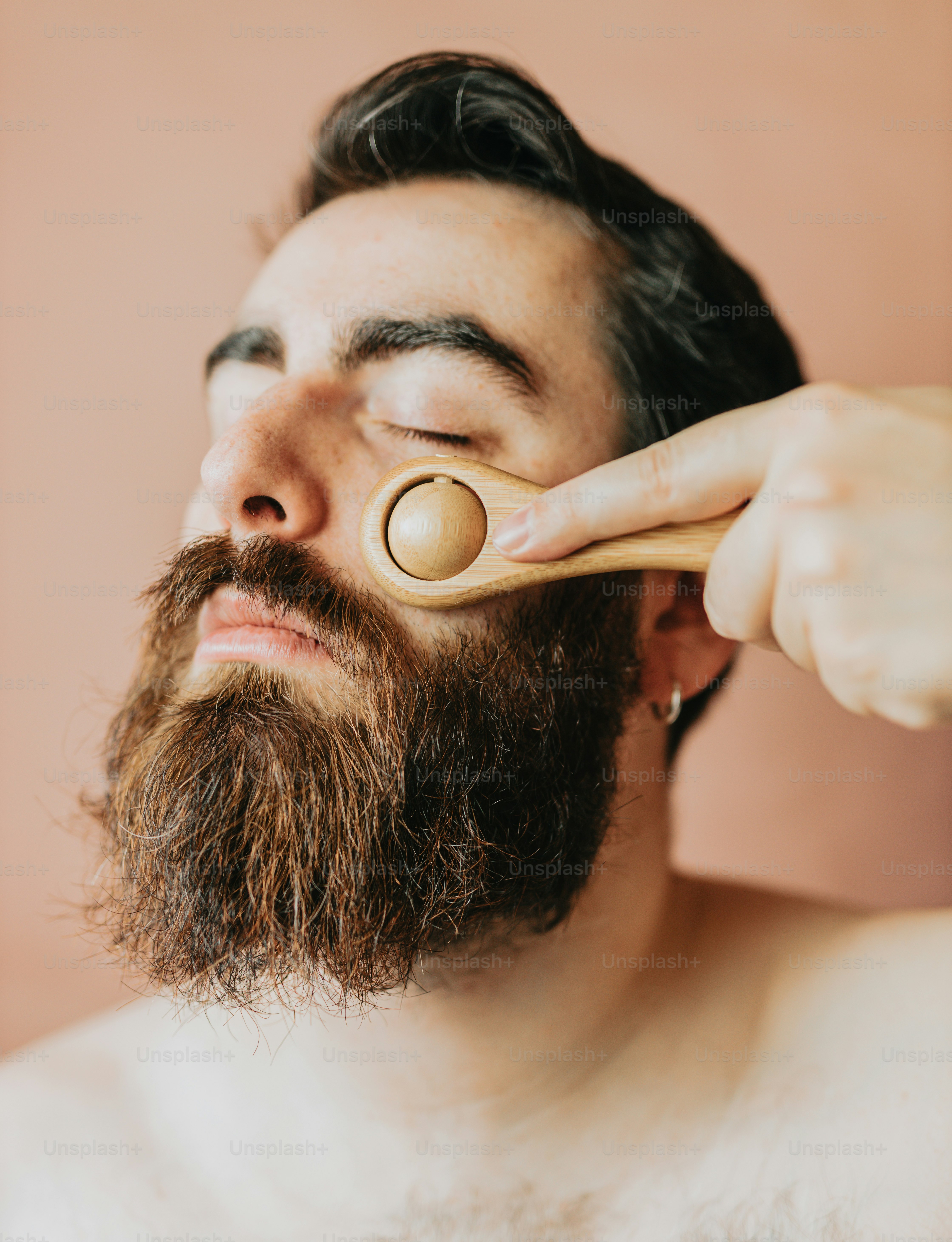 A man with a beard is brushing his teeth photo – Personal care Image on ...