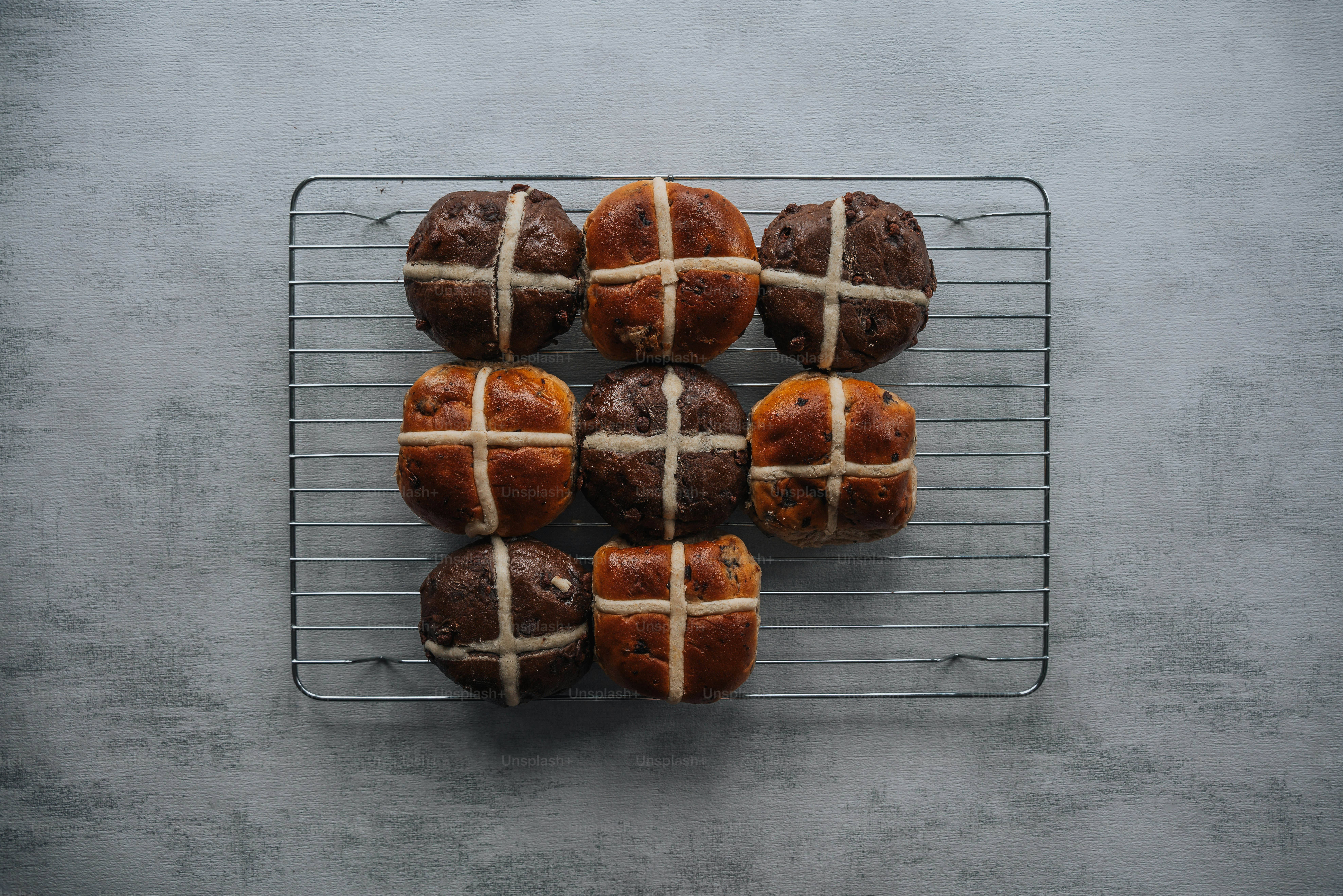 A bunch of hot cross buns on a cooling rack photo – Hot cross buns ...
