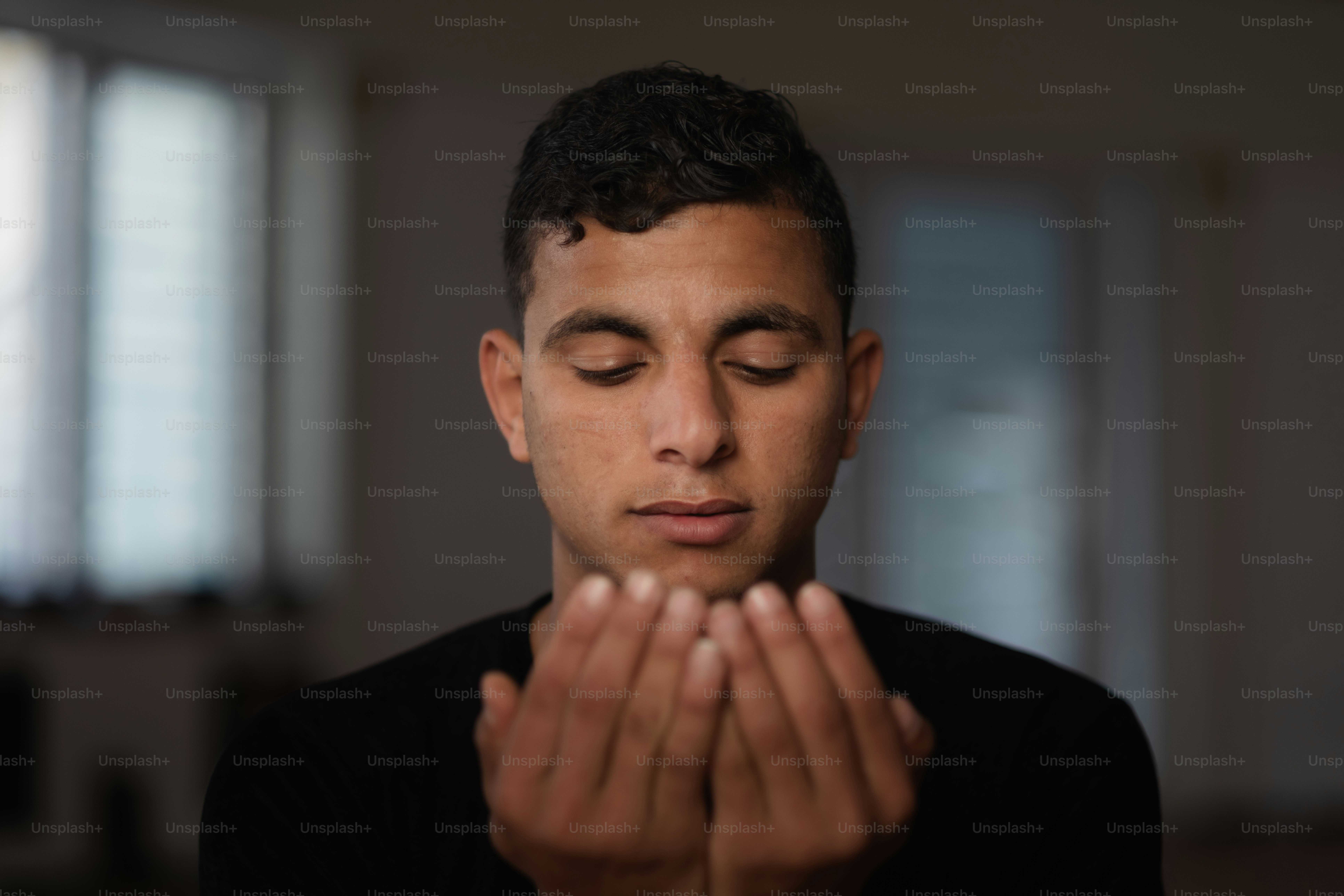 A young man is praying in a dark room photo – Worship Image on Unsplash
