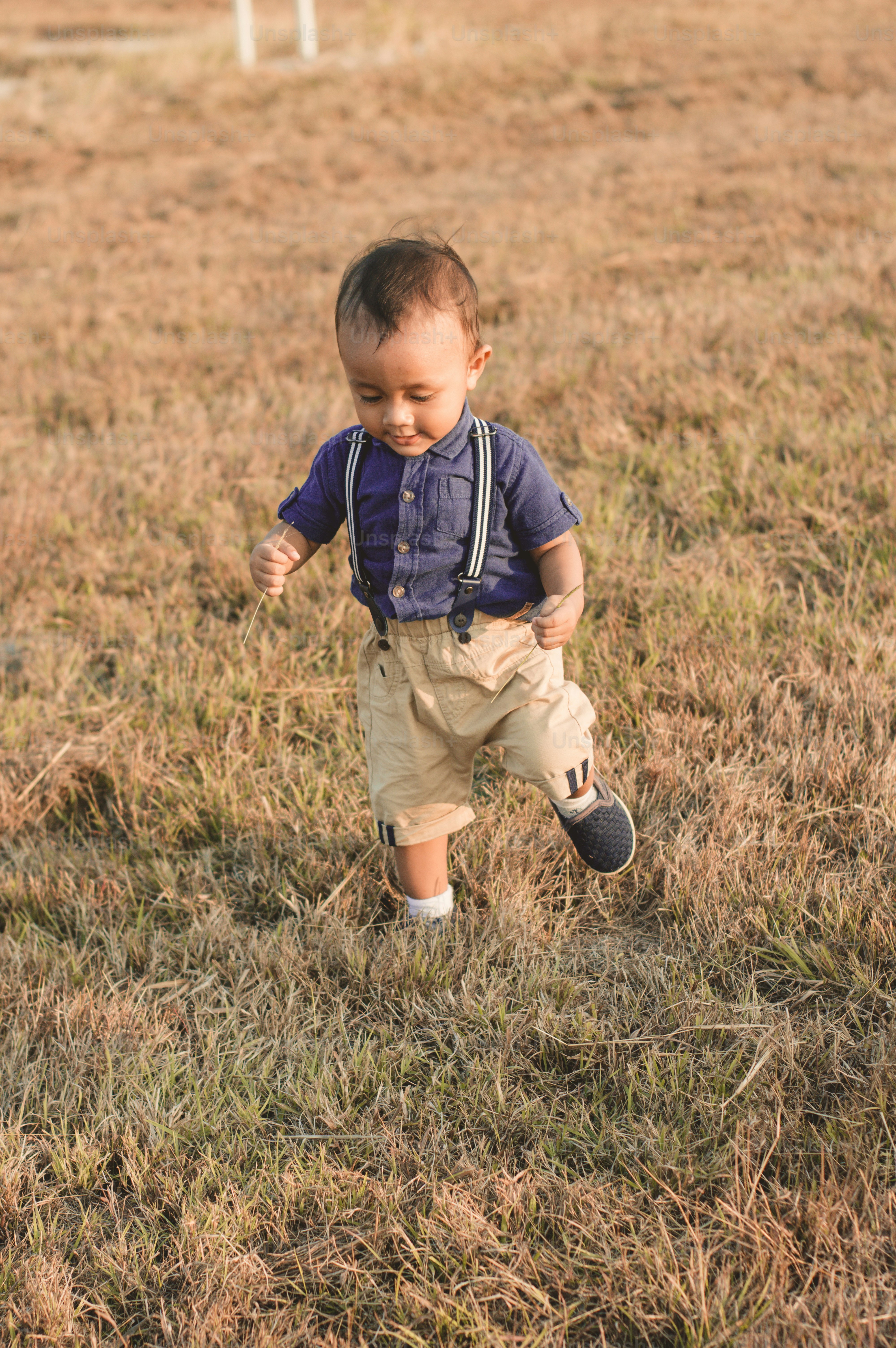 A little boy that is standing in the grass photo – Outdoors Image on ...