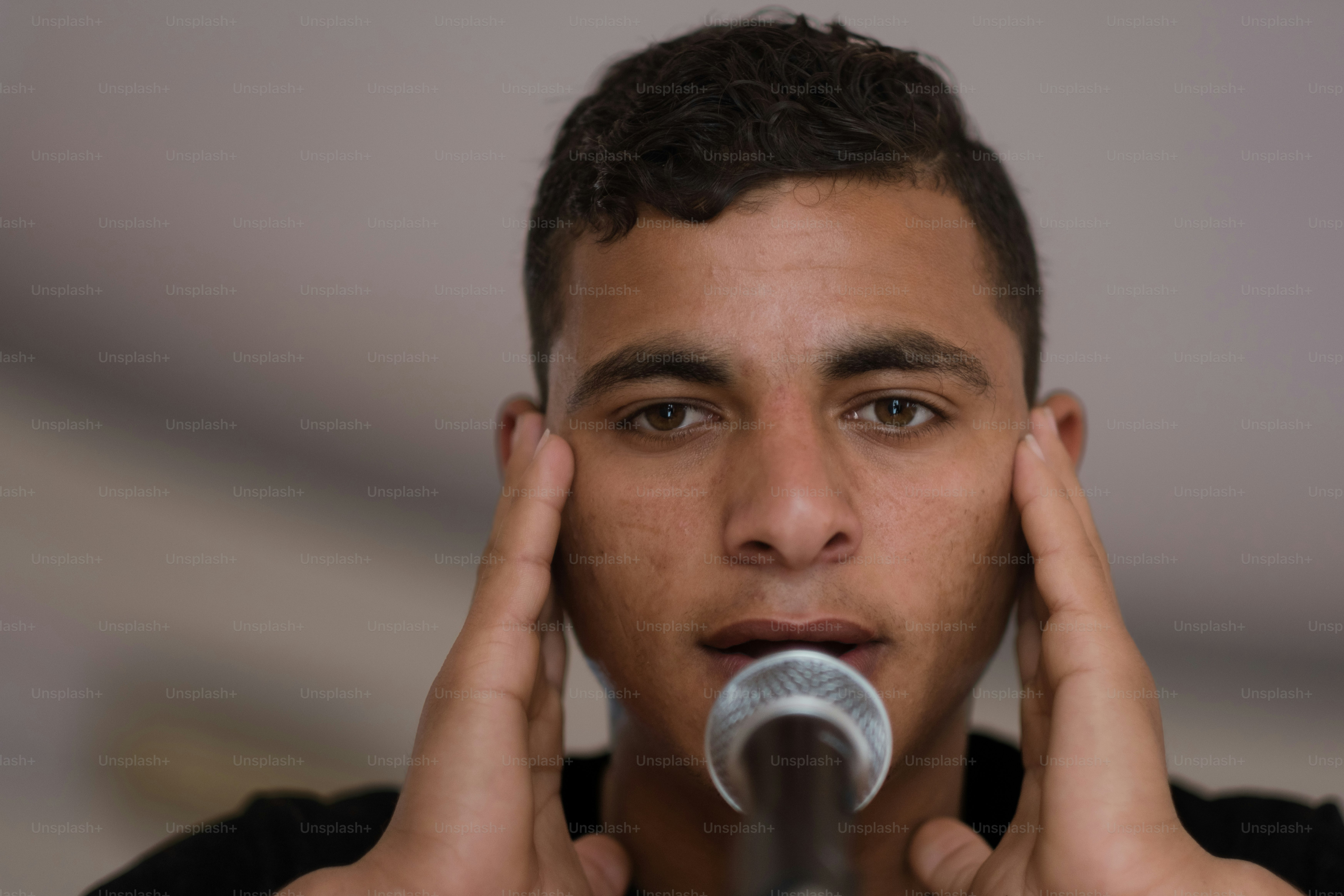 A man holding a microphone up to his face photo – Worship Image on Unsplash