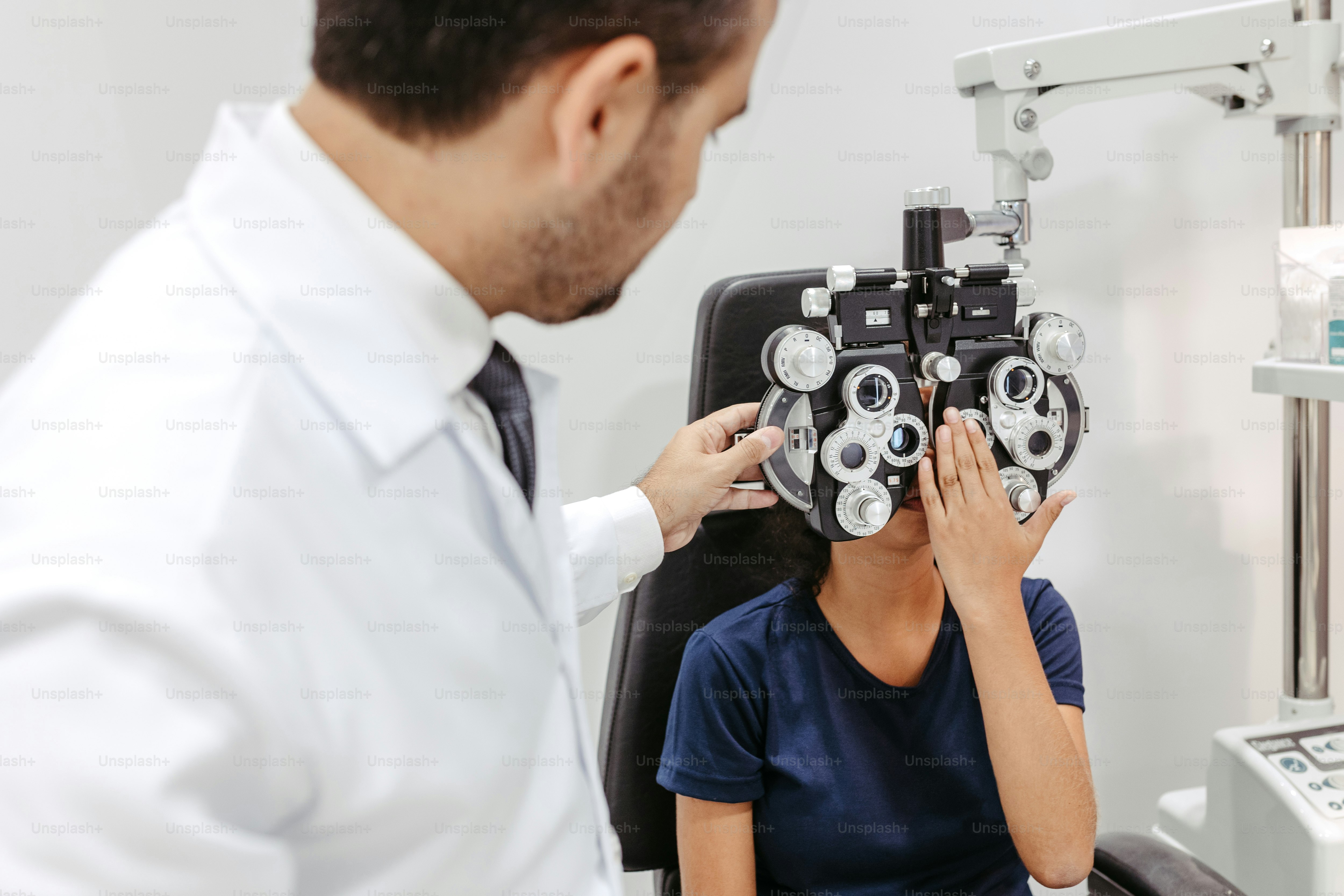 A woman getting her eye examined by a doctor photo – Ophthalmology ...