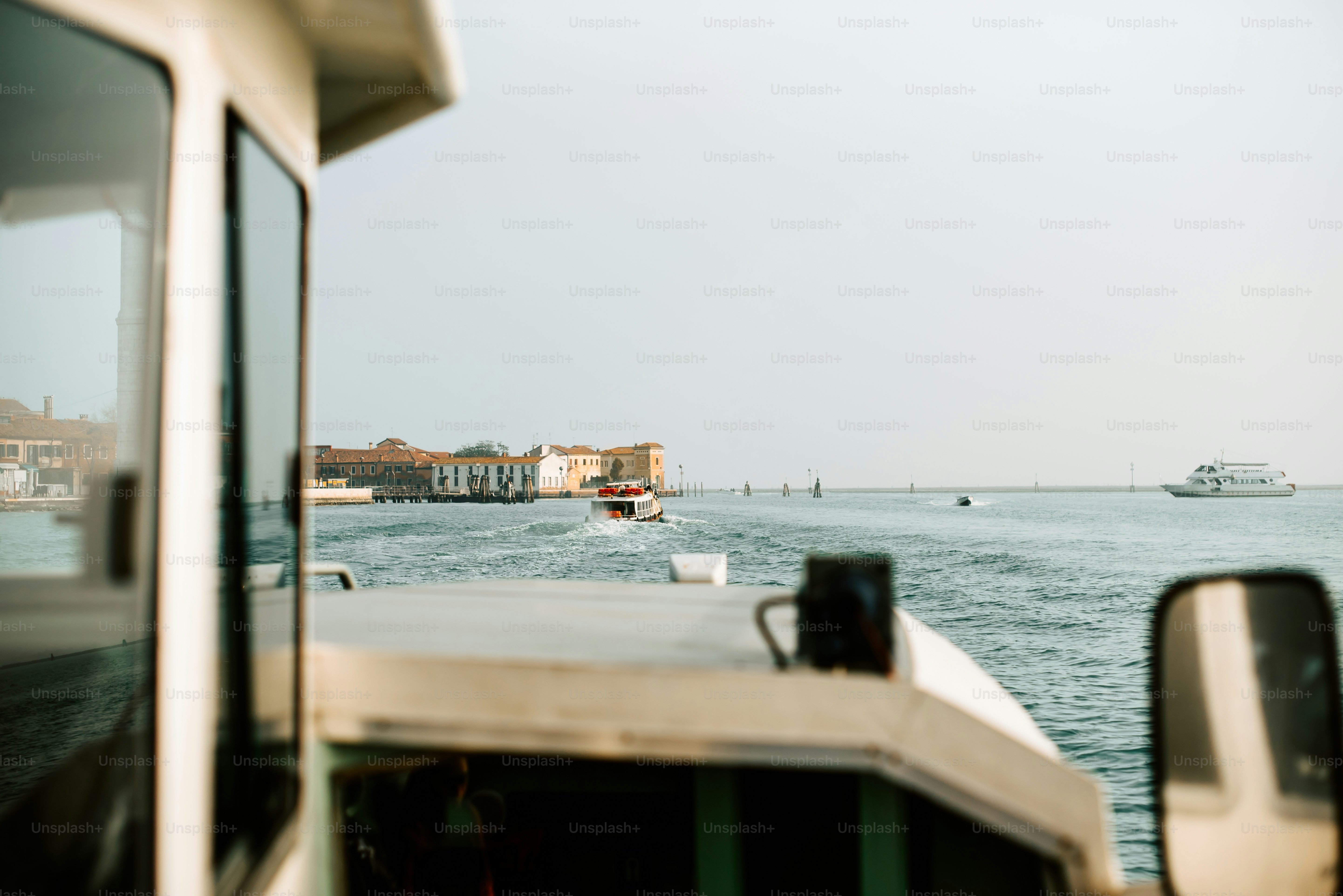 A boat traveling down a body of water photo – Transportation Image on ...