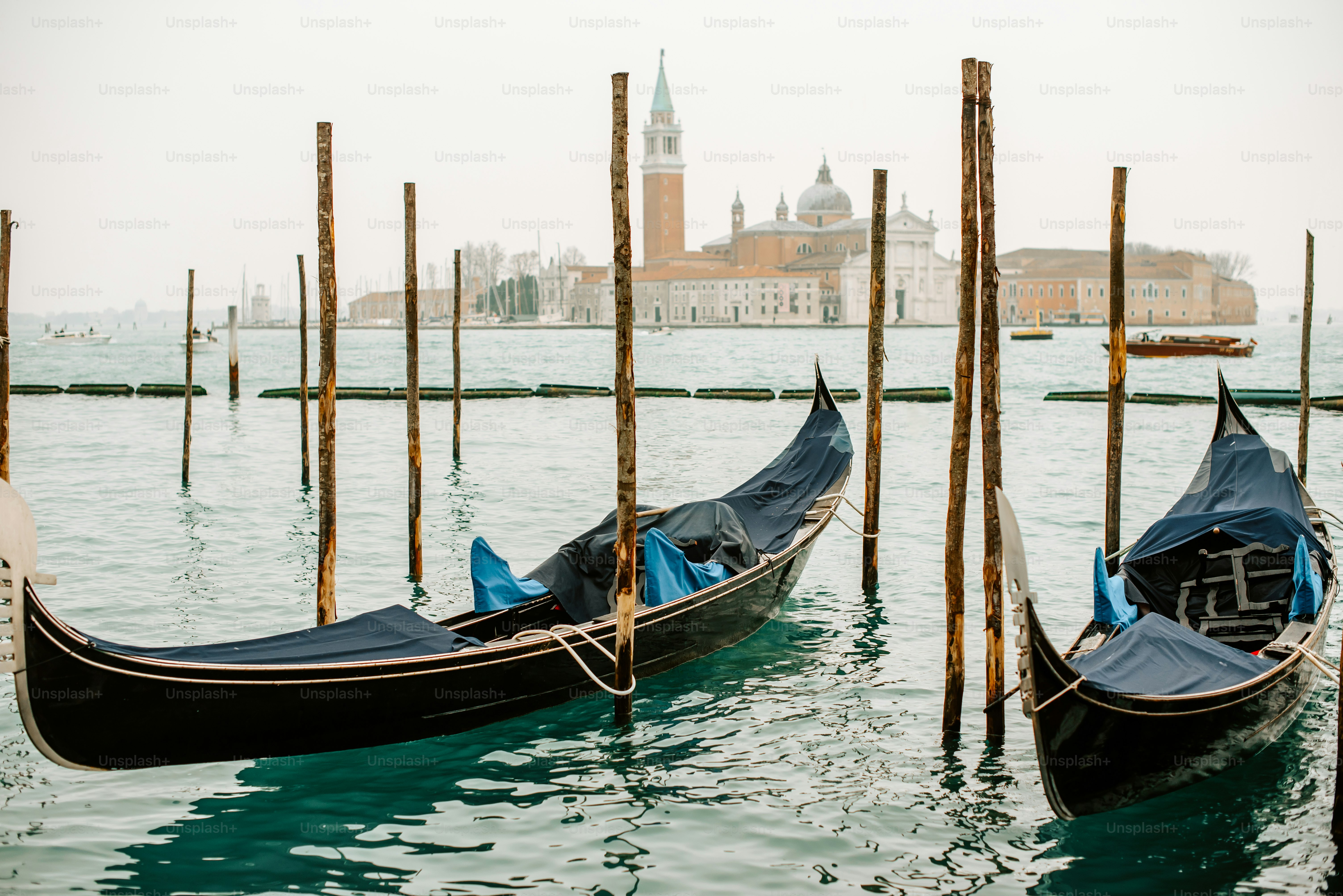 A couple of gondolas that are sitting in the water photo – Outdoors ...