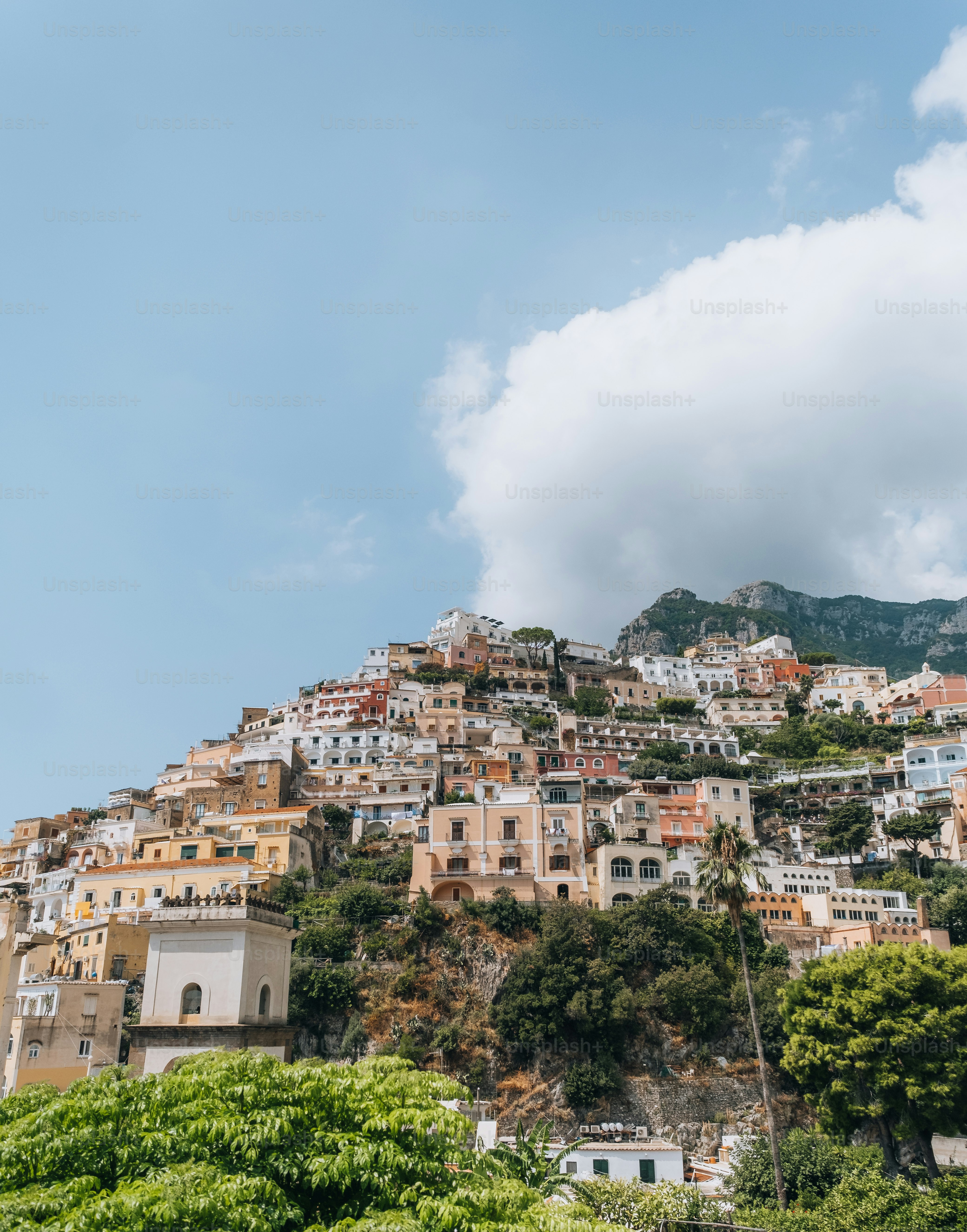 A hill with a bunch of buildings on top of it photo – Positano Image on ...