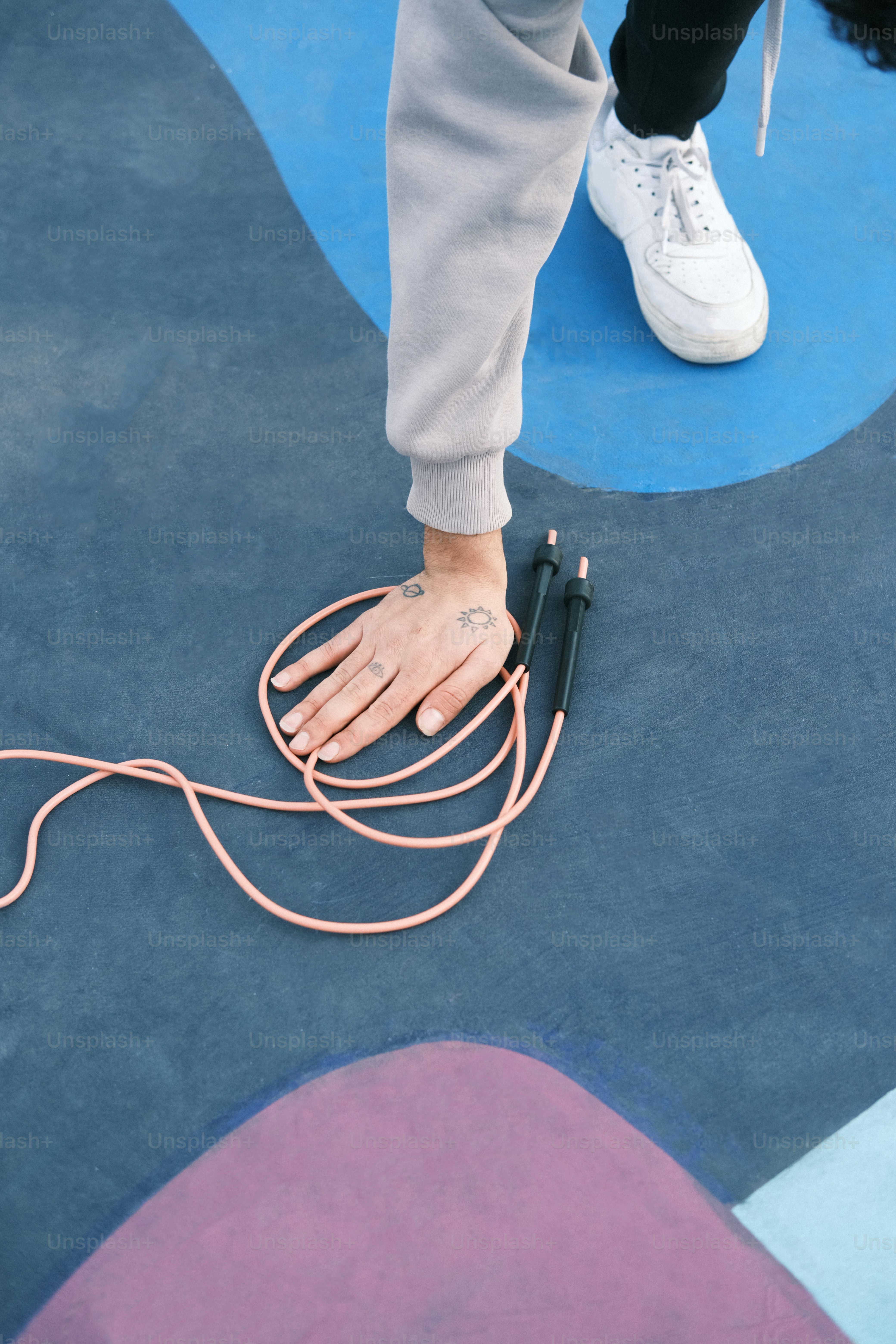 A person standing on top of a blue and purple floor photo – Skipping ...