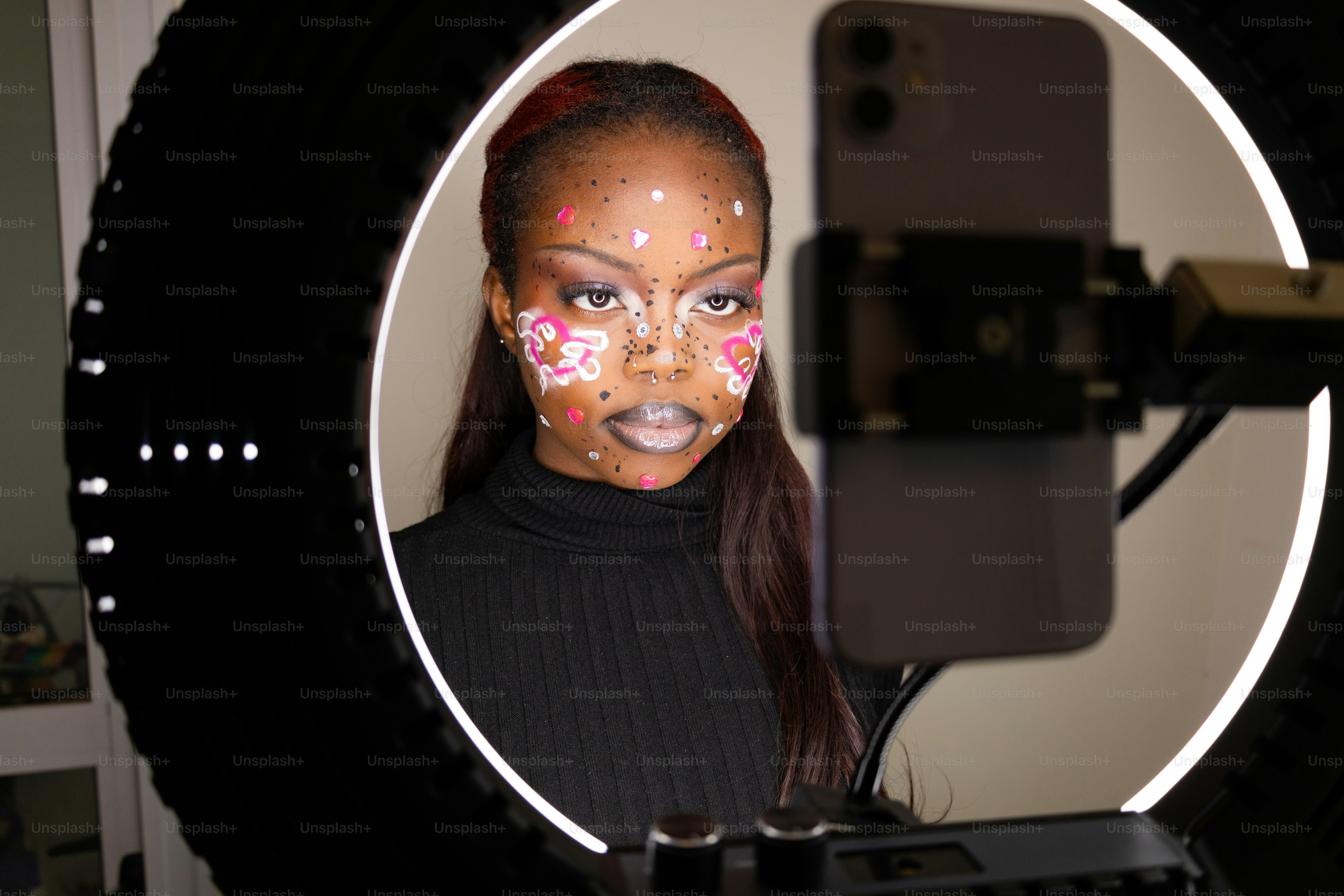 A woman with face paint and a camera photo – Influencer Image on Unsplash