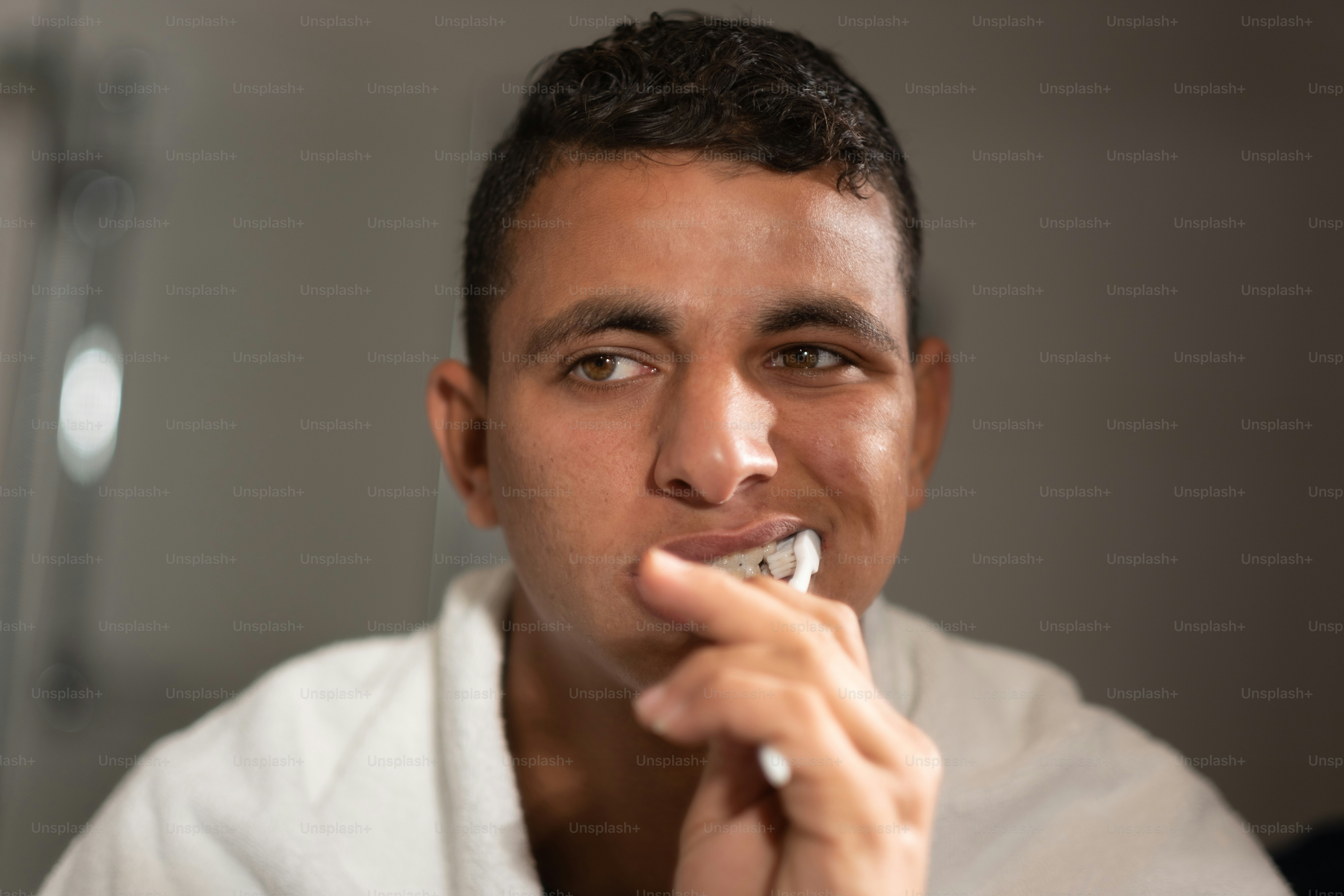 A man brushing his teeth with a tooth brush photo – Dental care Image ...