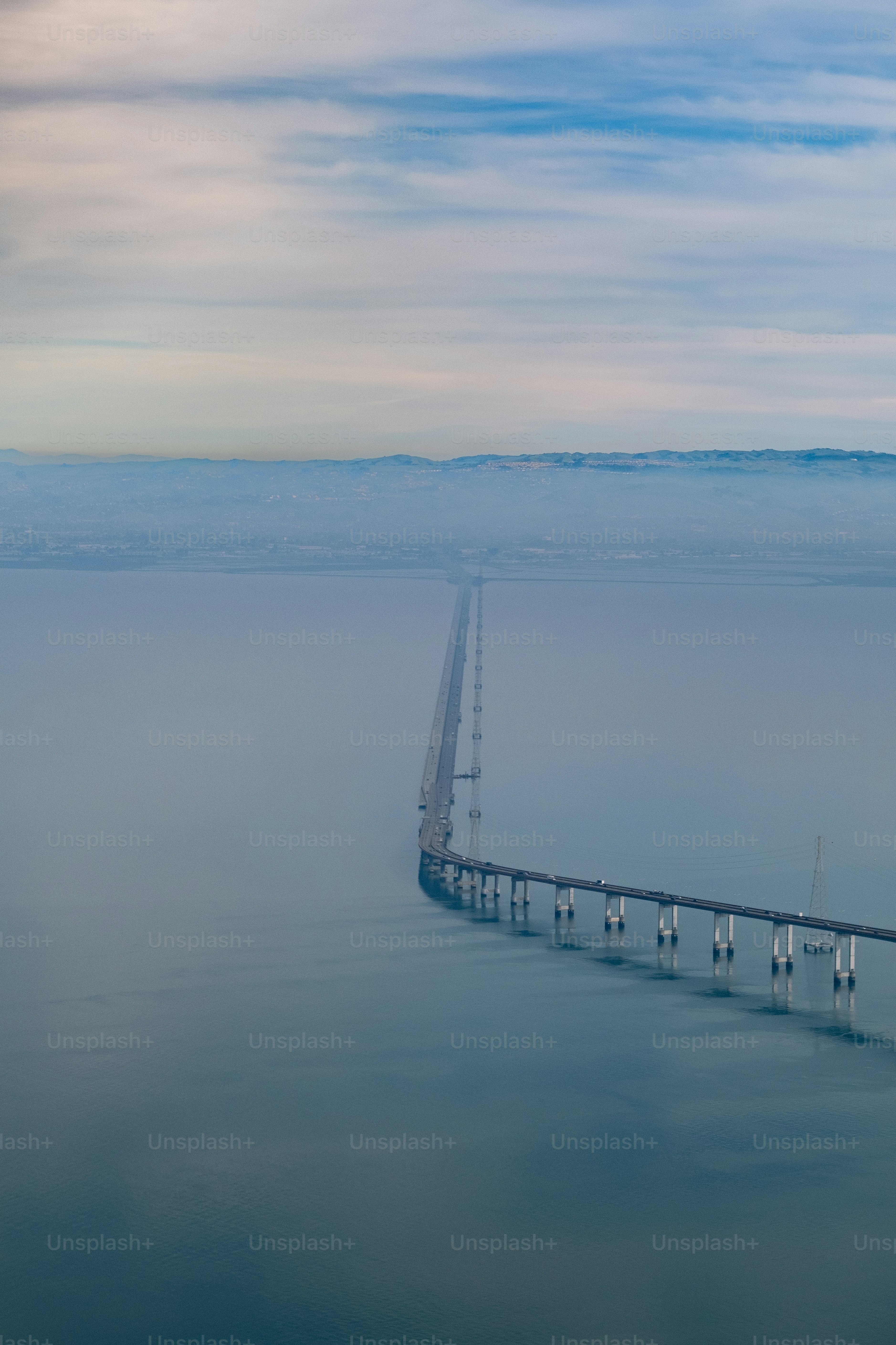 An aerial view of a long bridge over water photo – Bridge Image on Unsplash