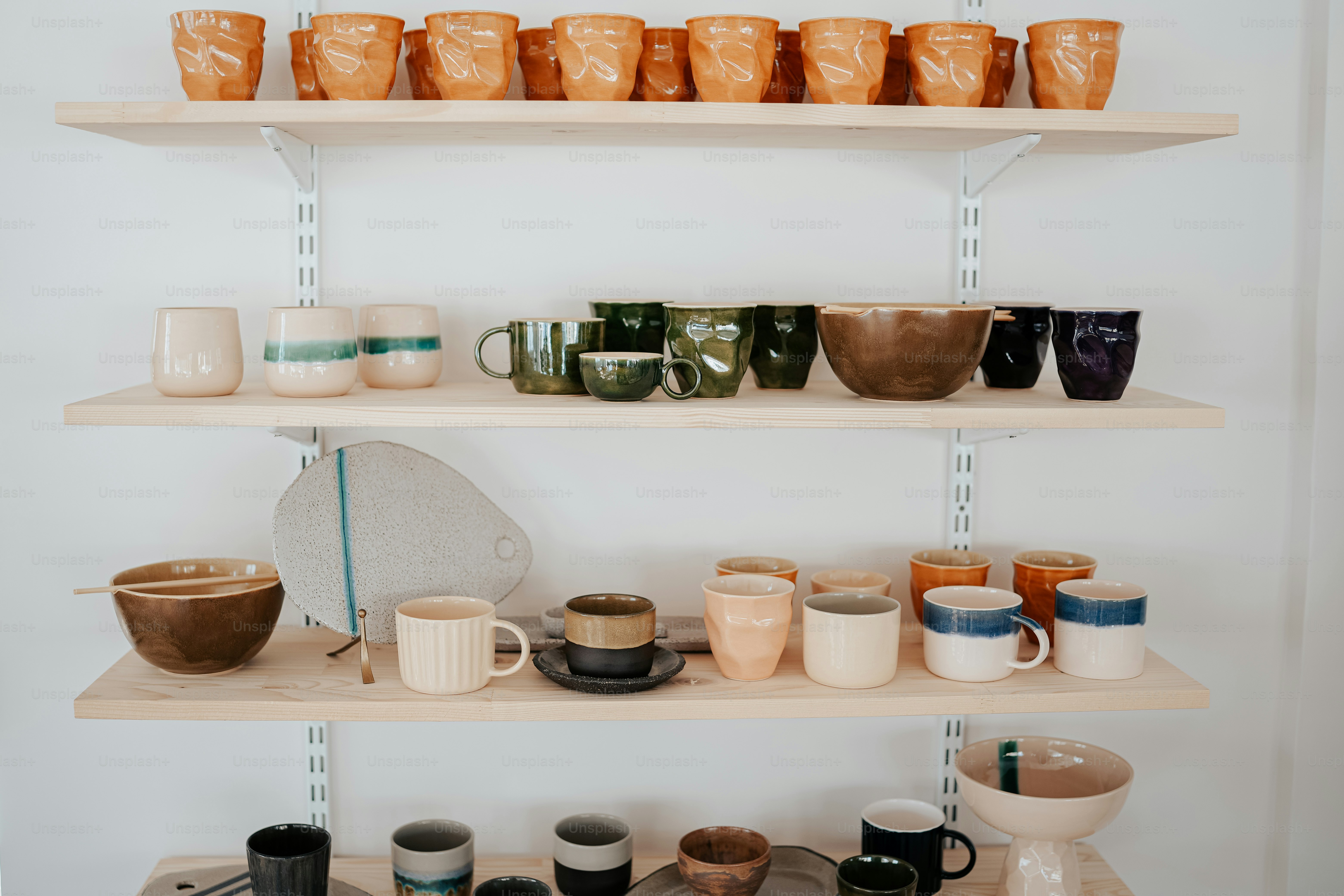 A couple of shelves filled with lots of cups photo – Ceramics Image on ...