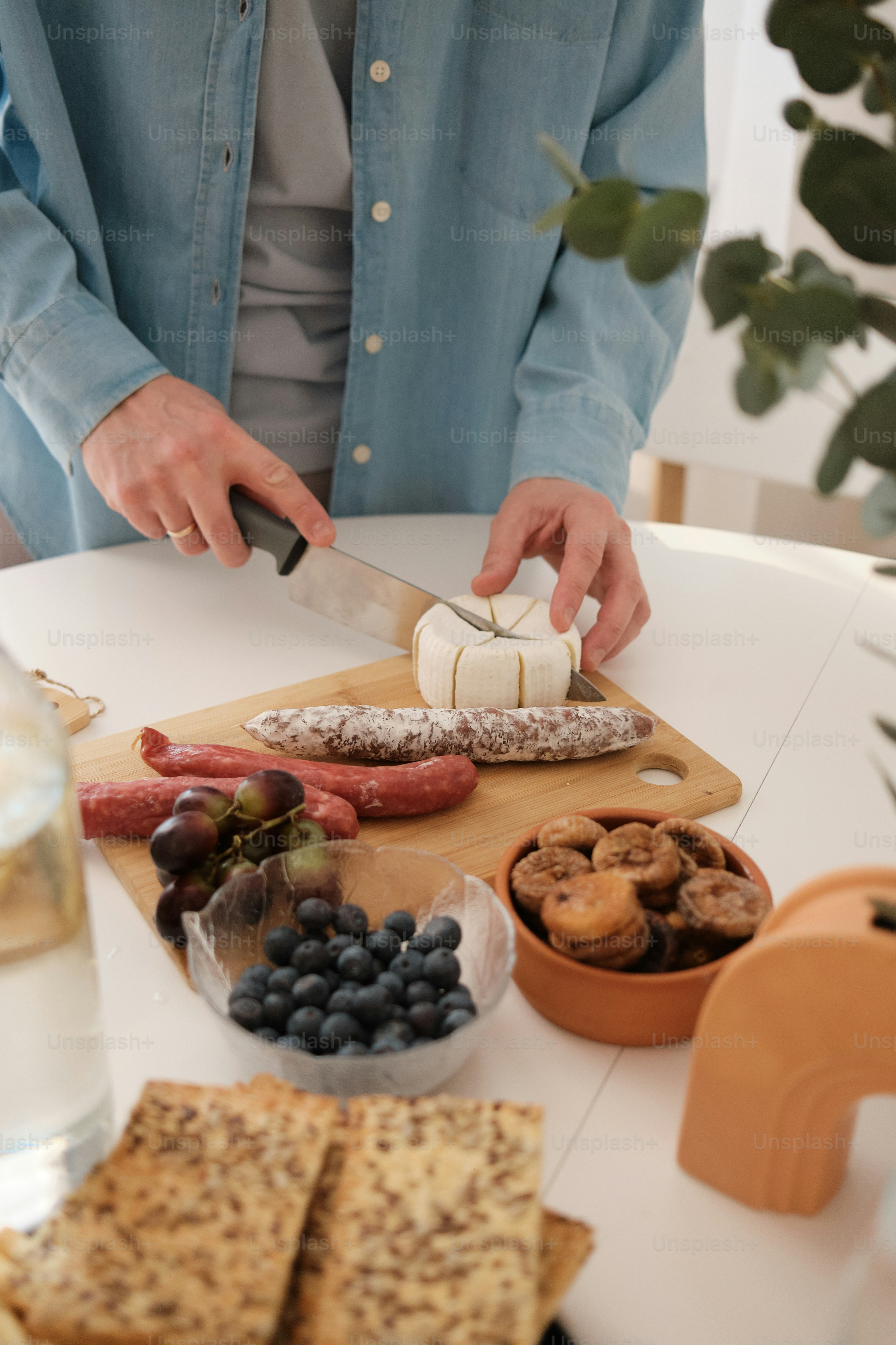 A person cutting up food on a cutting board photo – Birthday Image on ...