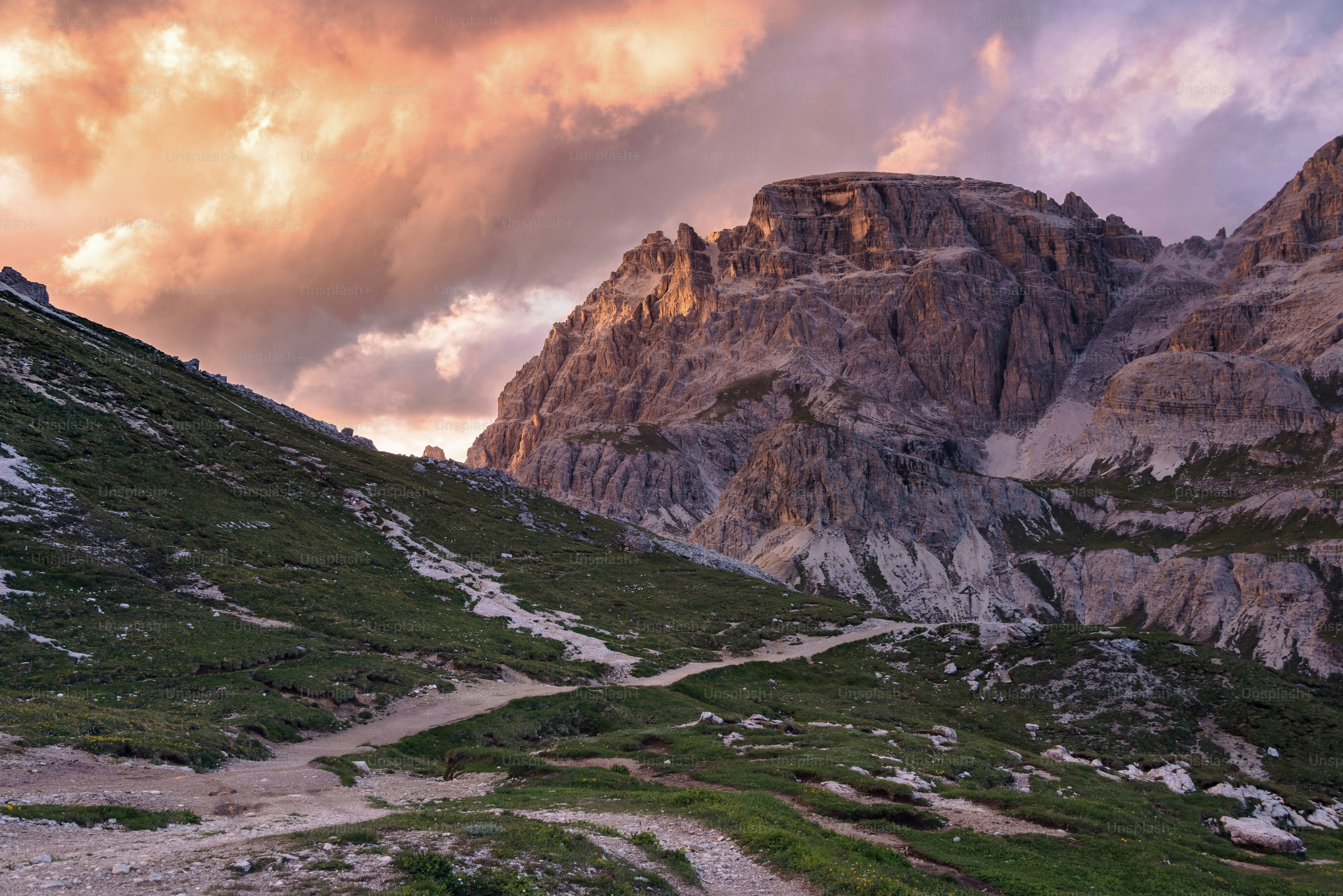 A mountain with a trail going up the side of it photo – Mountain range ...
