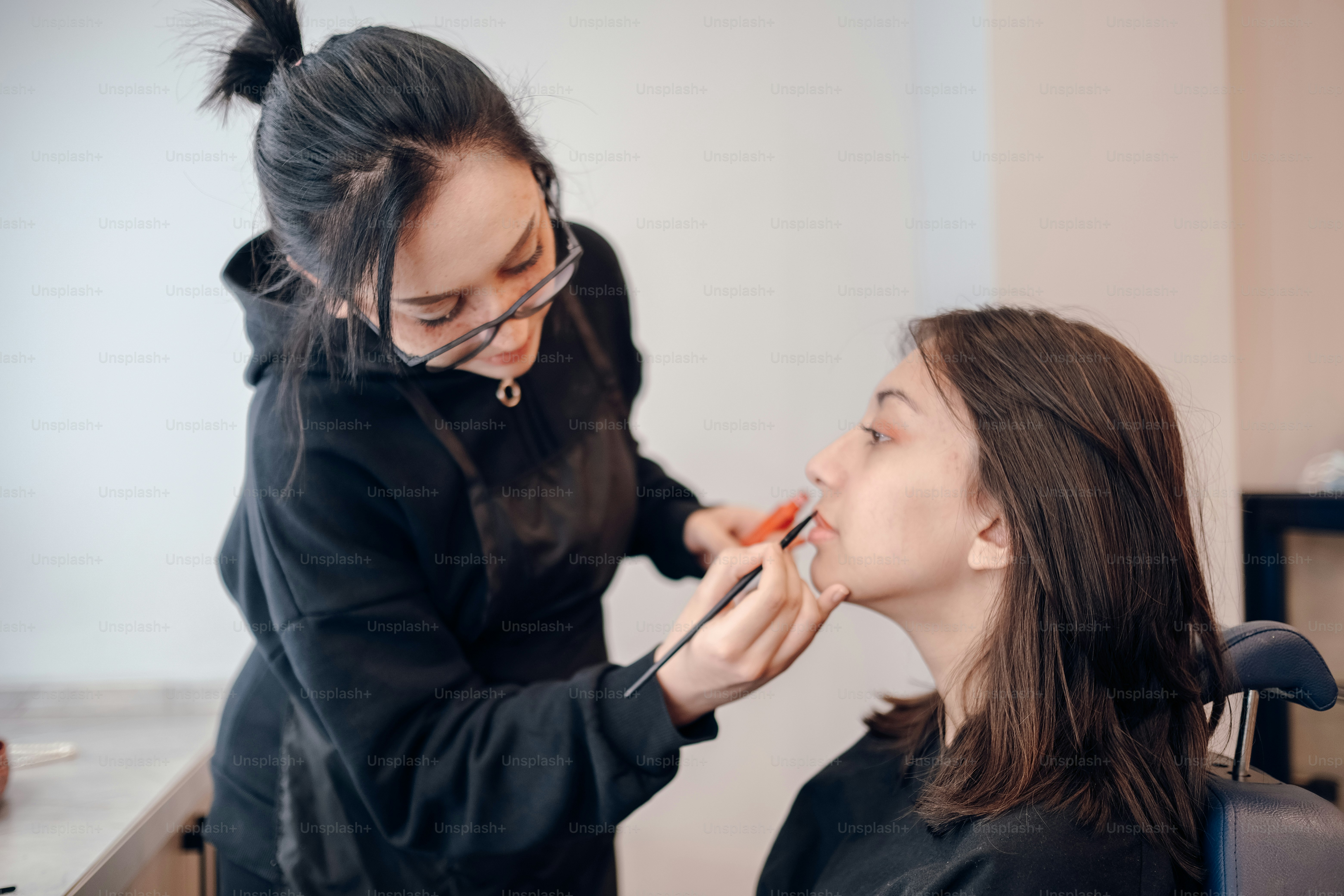 A woman getting her teeth brushed by a woman in a chair photo ...