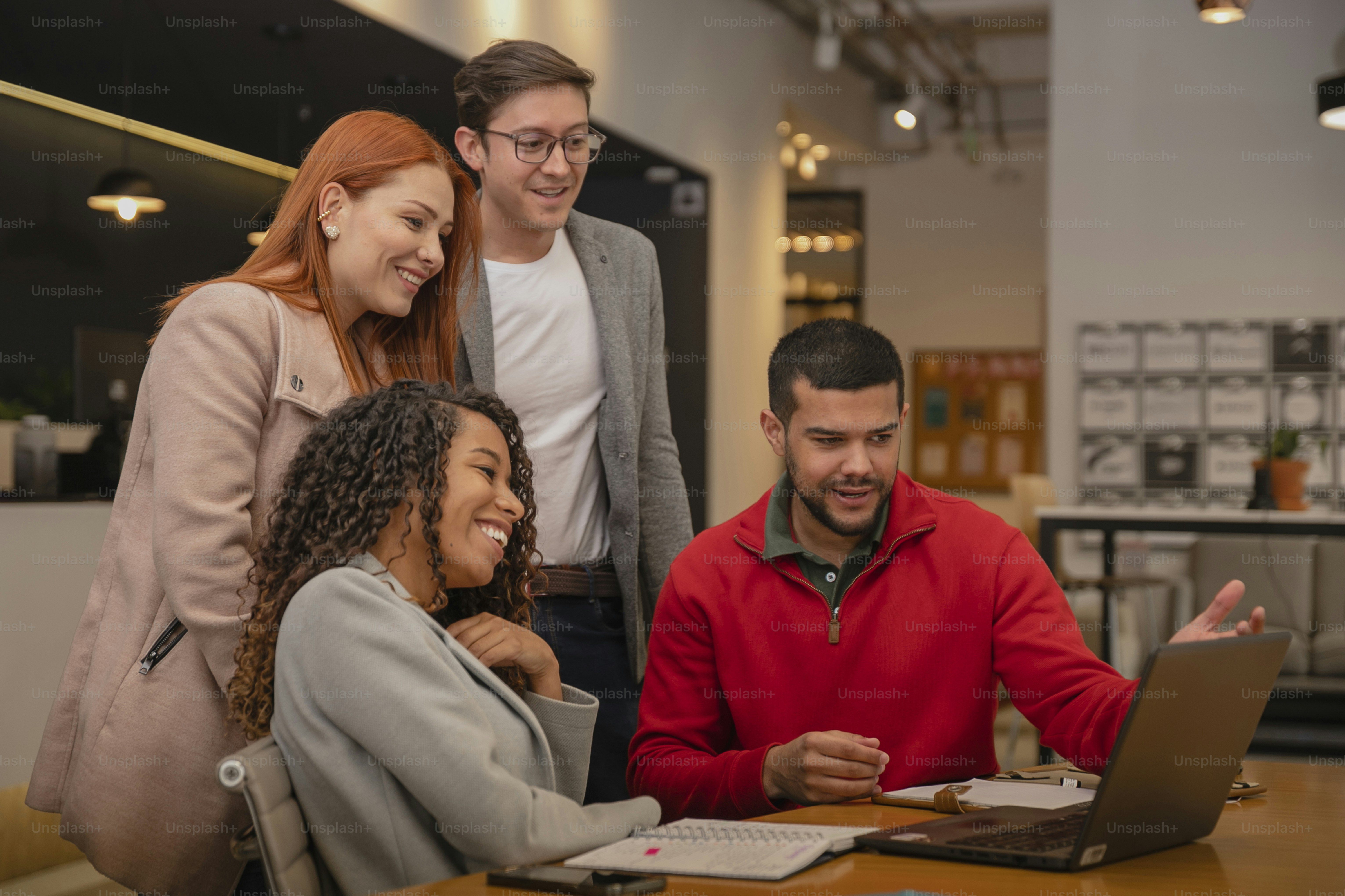 A group of people standing around a laptop computer photo – Office ...