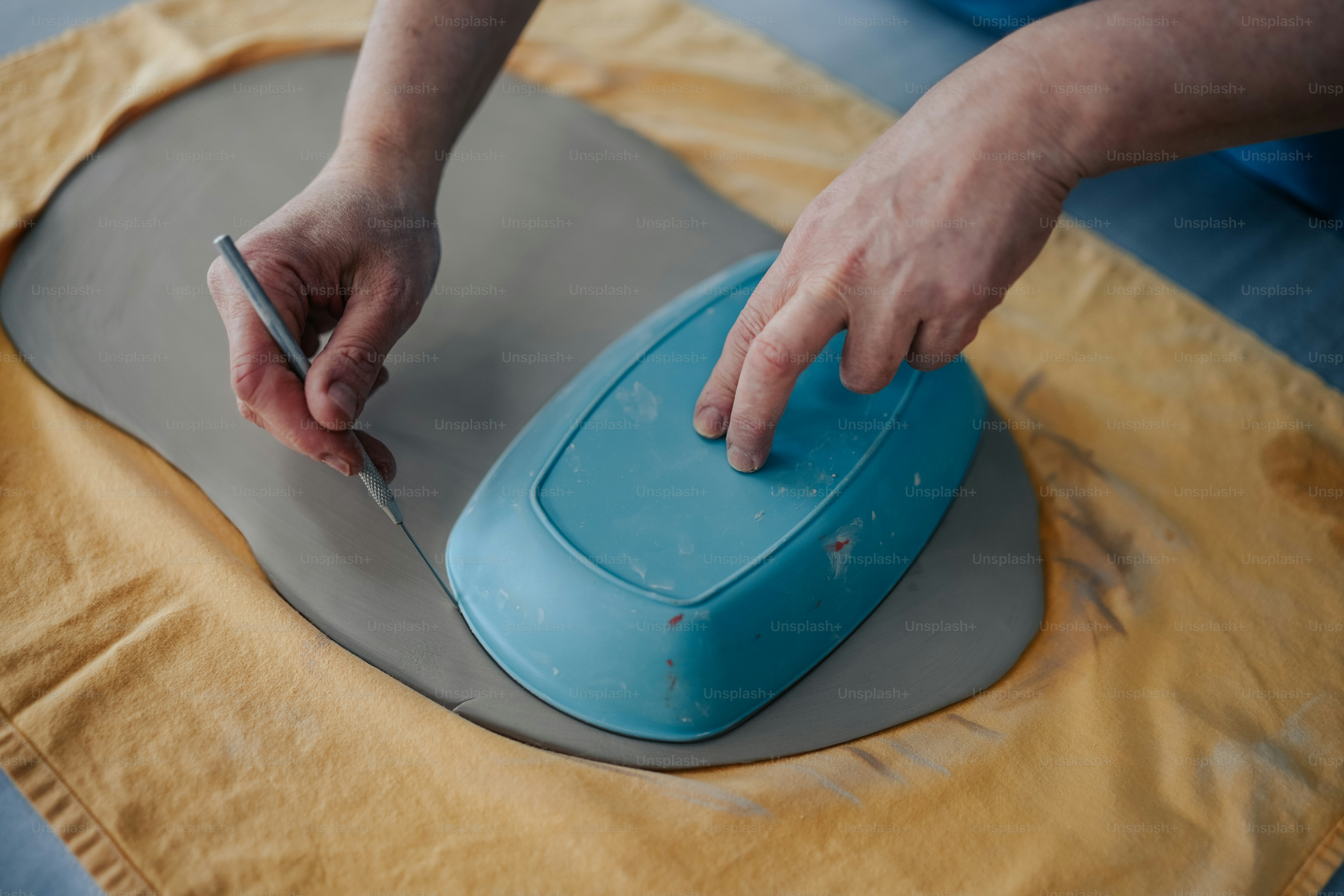A person cutting a piece of plastic with a knife photo – Hands Image on ...