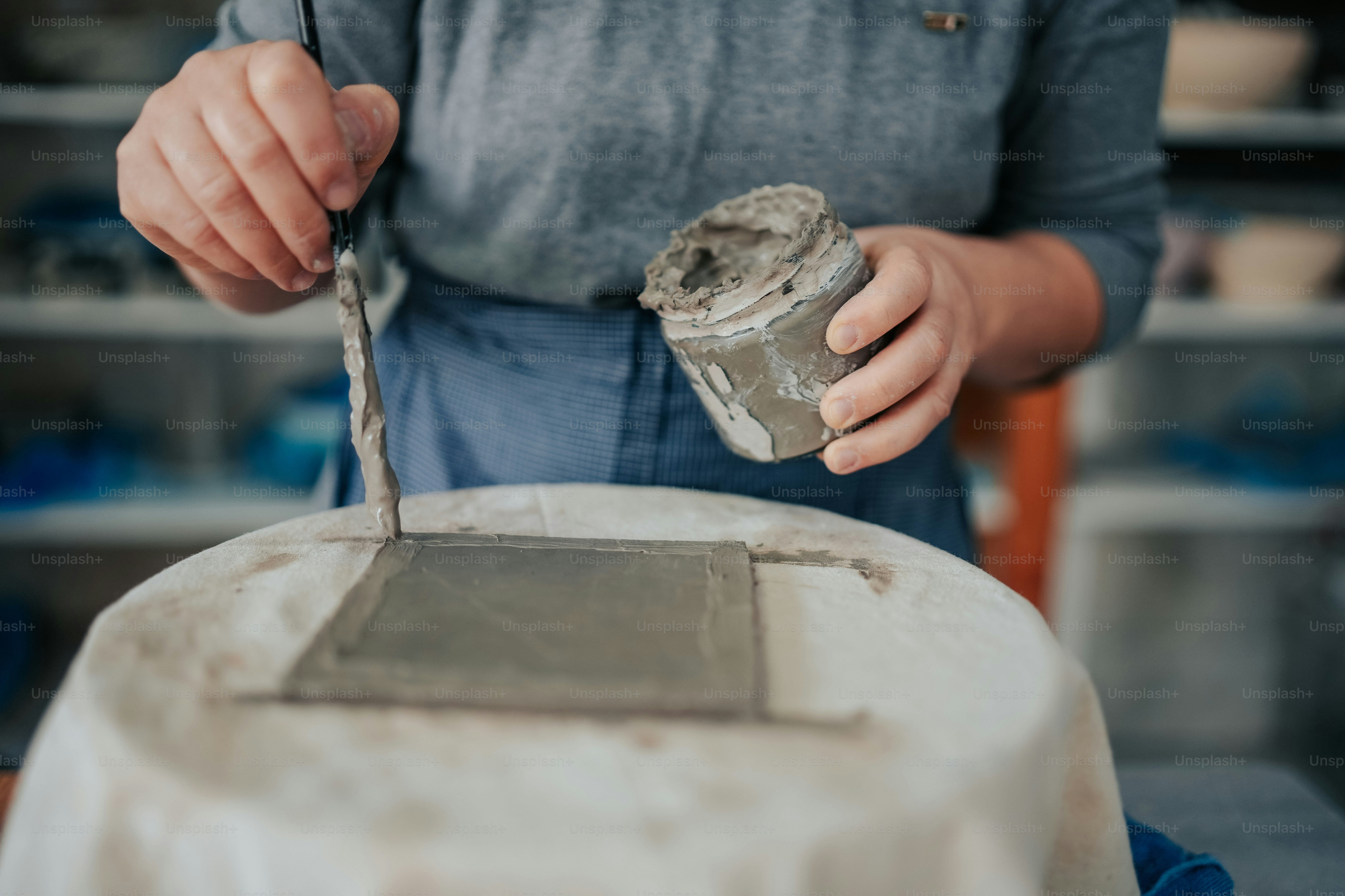 A person using a small tool on a piece of metal photo – Painting Image ...