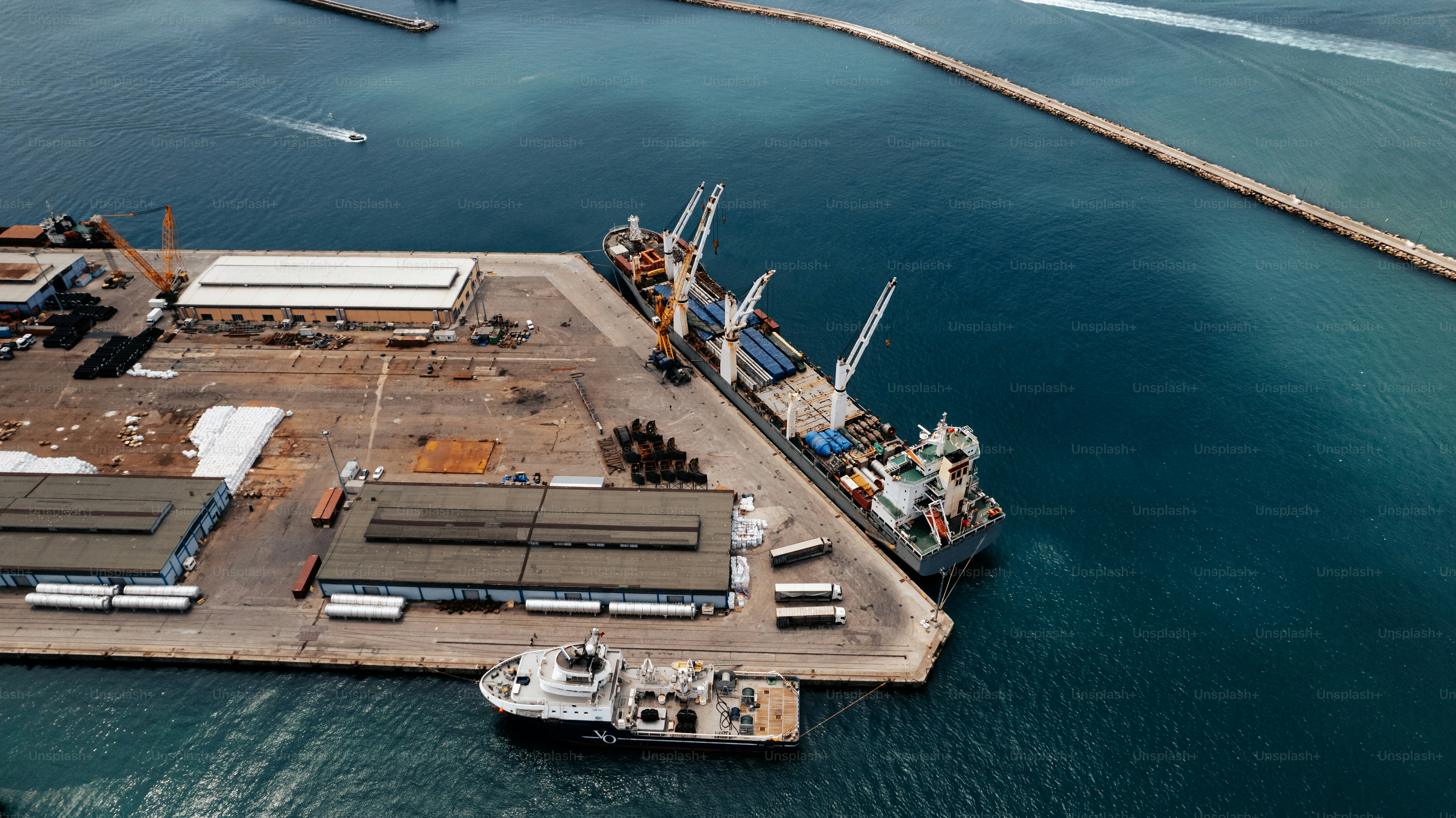 An aerial view of a cargo ship docked at a dock photo – Ports Image on ...