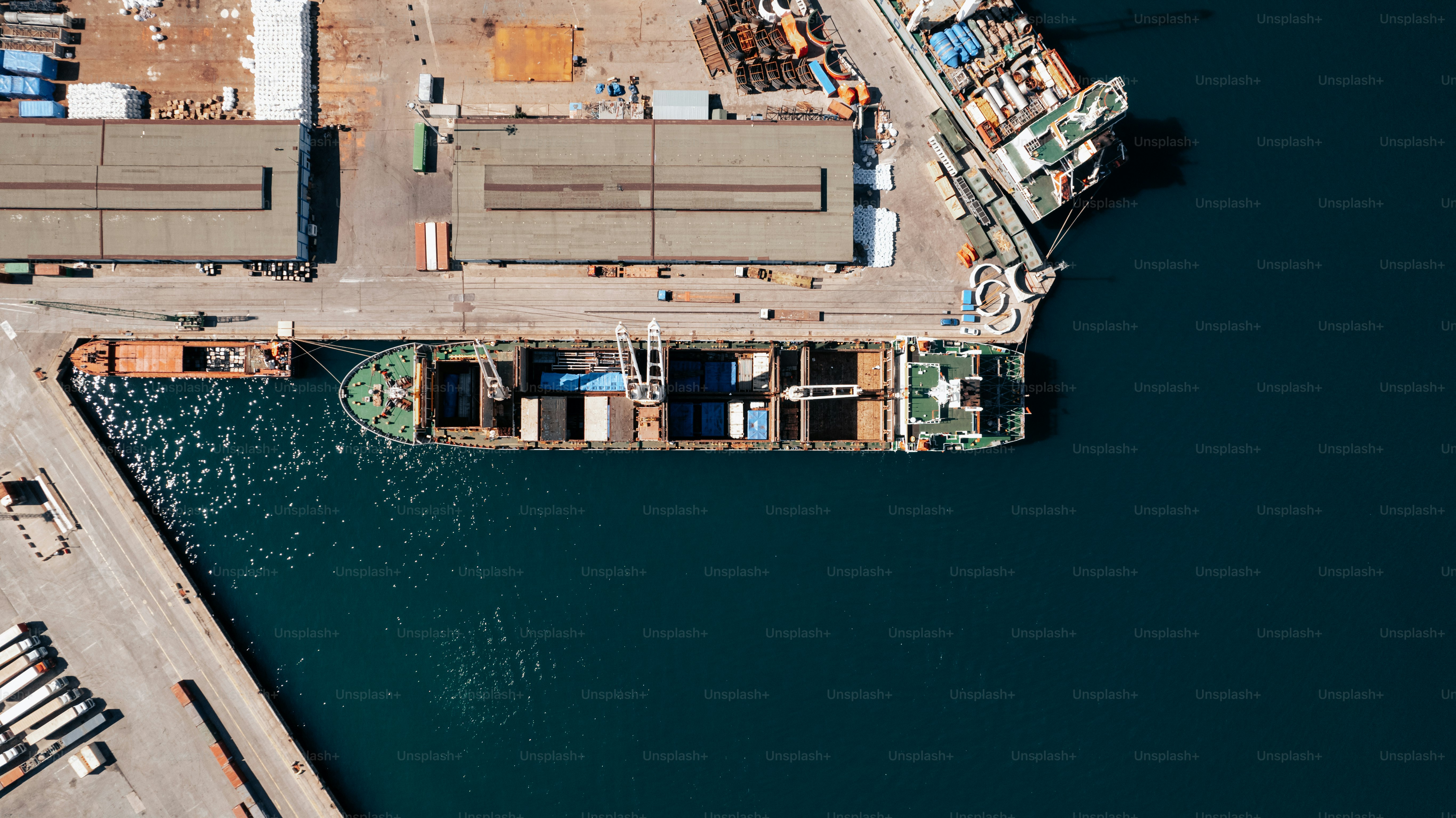 An aerial view of a cargo ship docked at a dock photo – Ports Image on ...