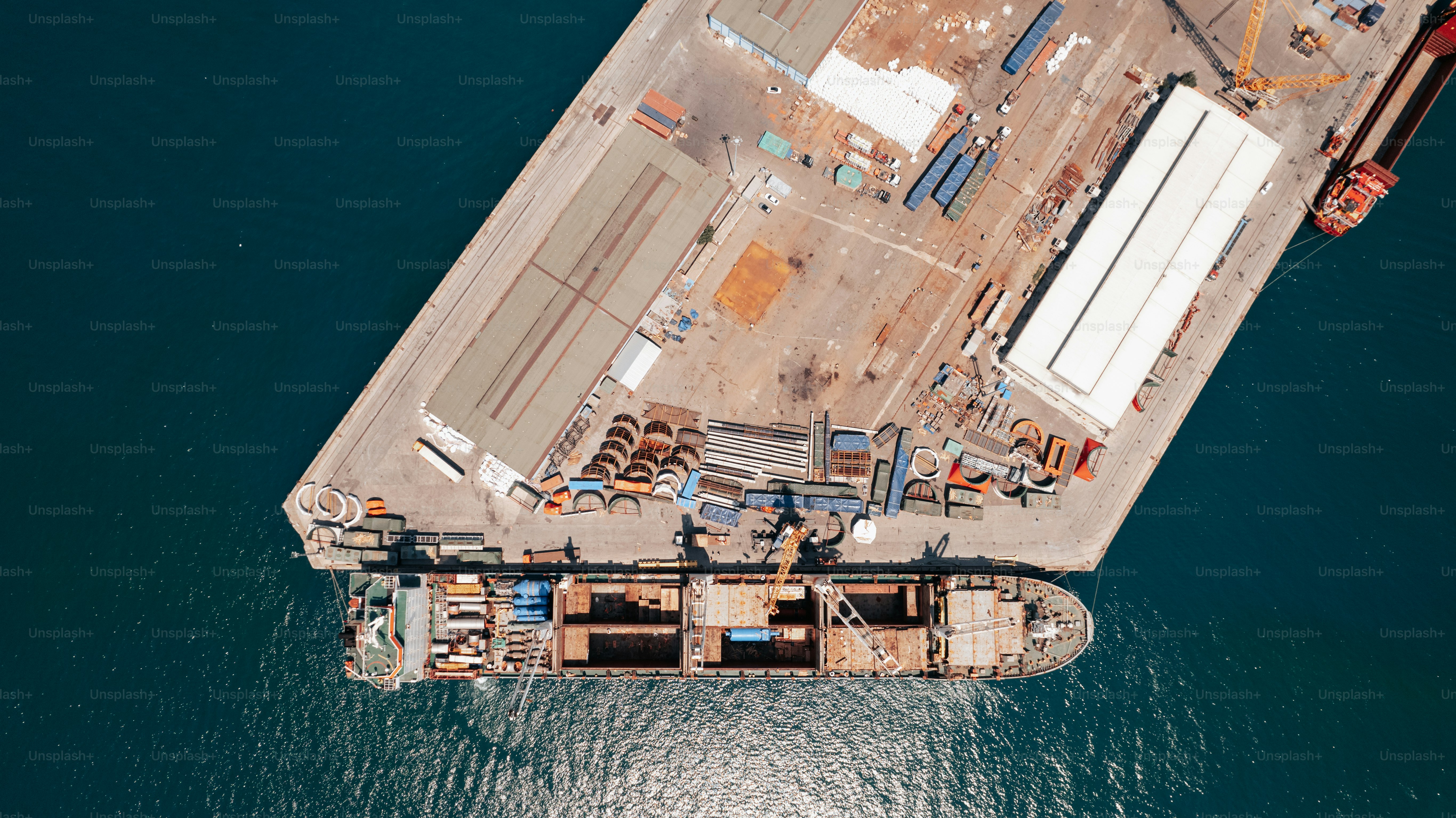 An aerial view of a cargo ship in the water photo – Commodity Image on ...