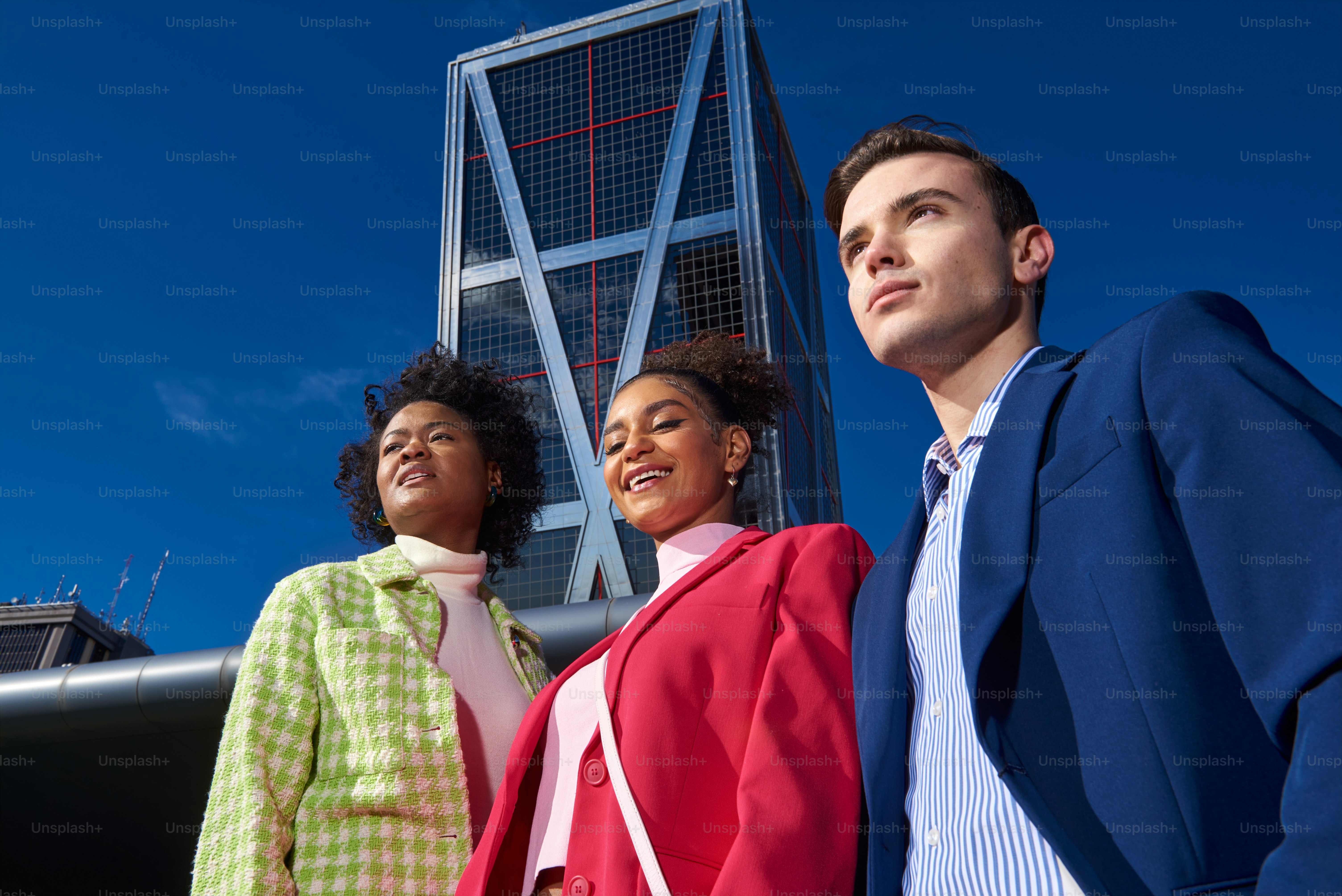 A group of three people standing next to each other photo – People ...