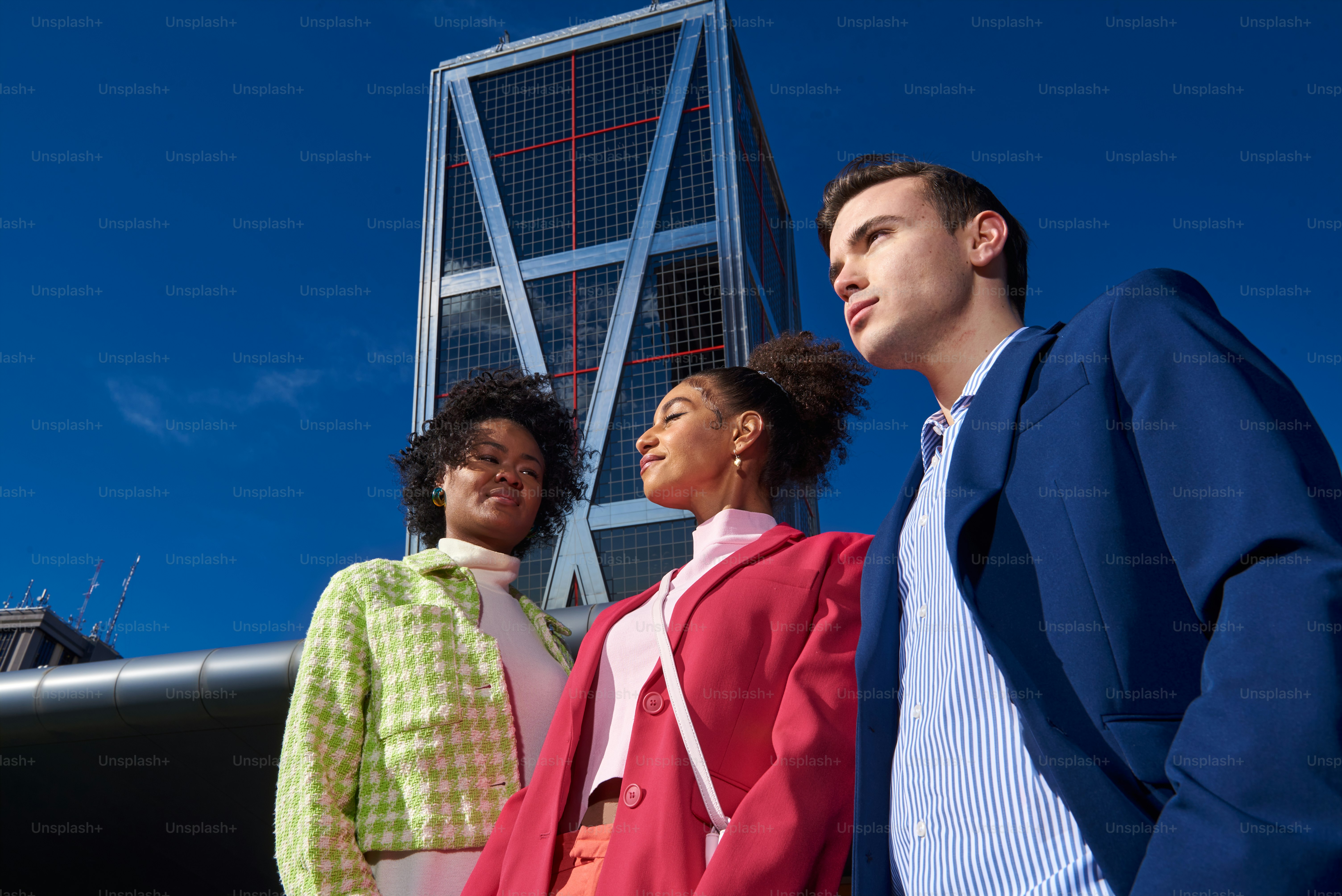 A group of three people standing next to each other photo – People ...