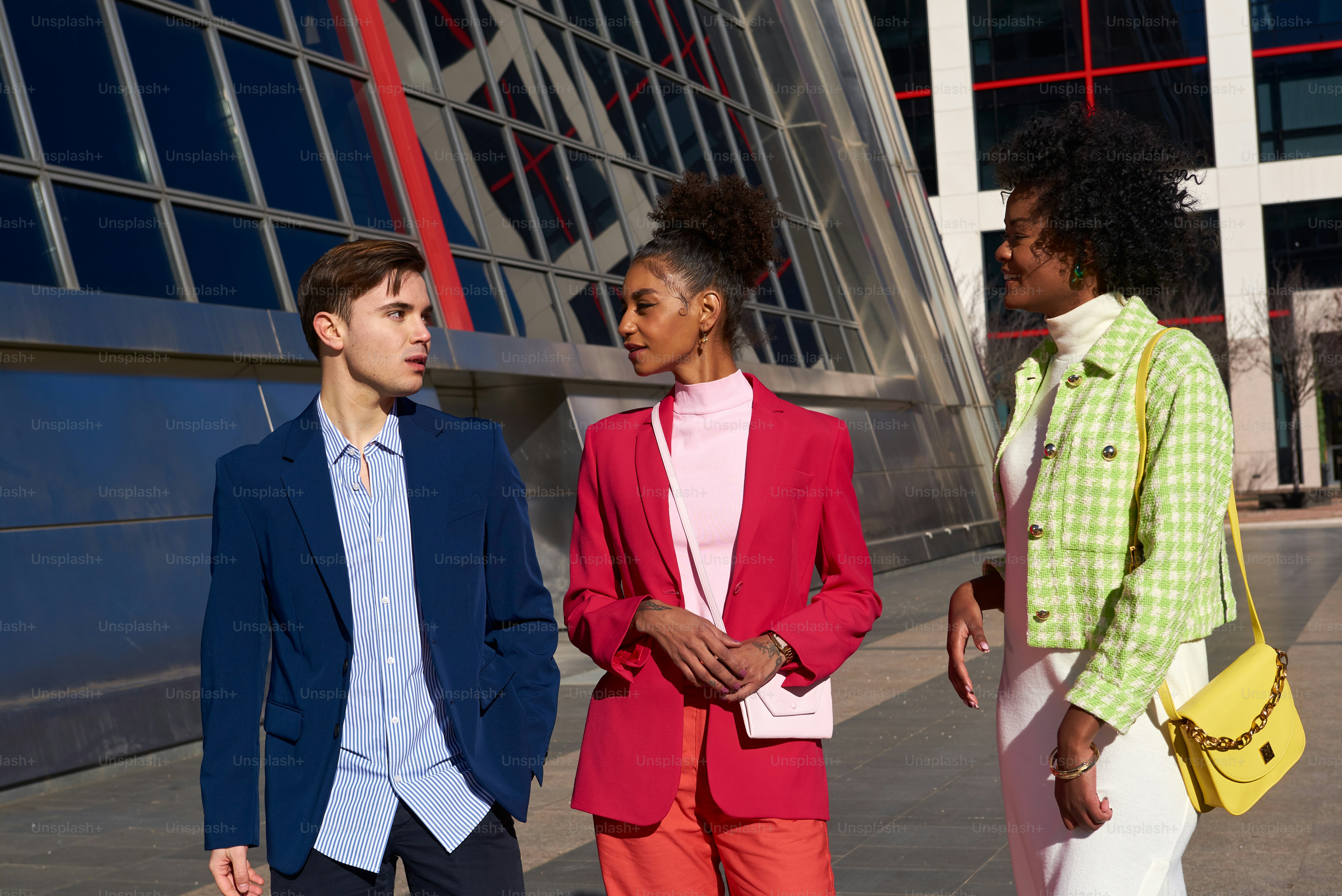 A group of three people standing next to each other photo – Meeting ...
