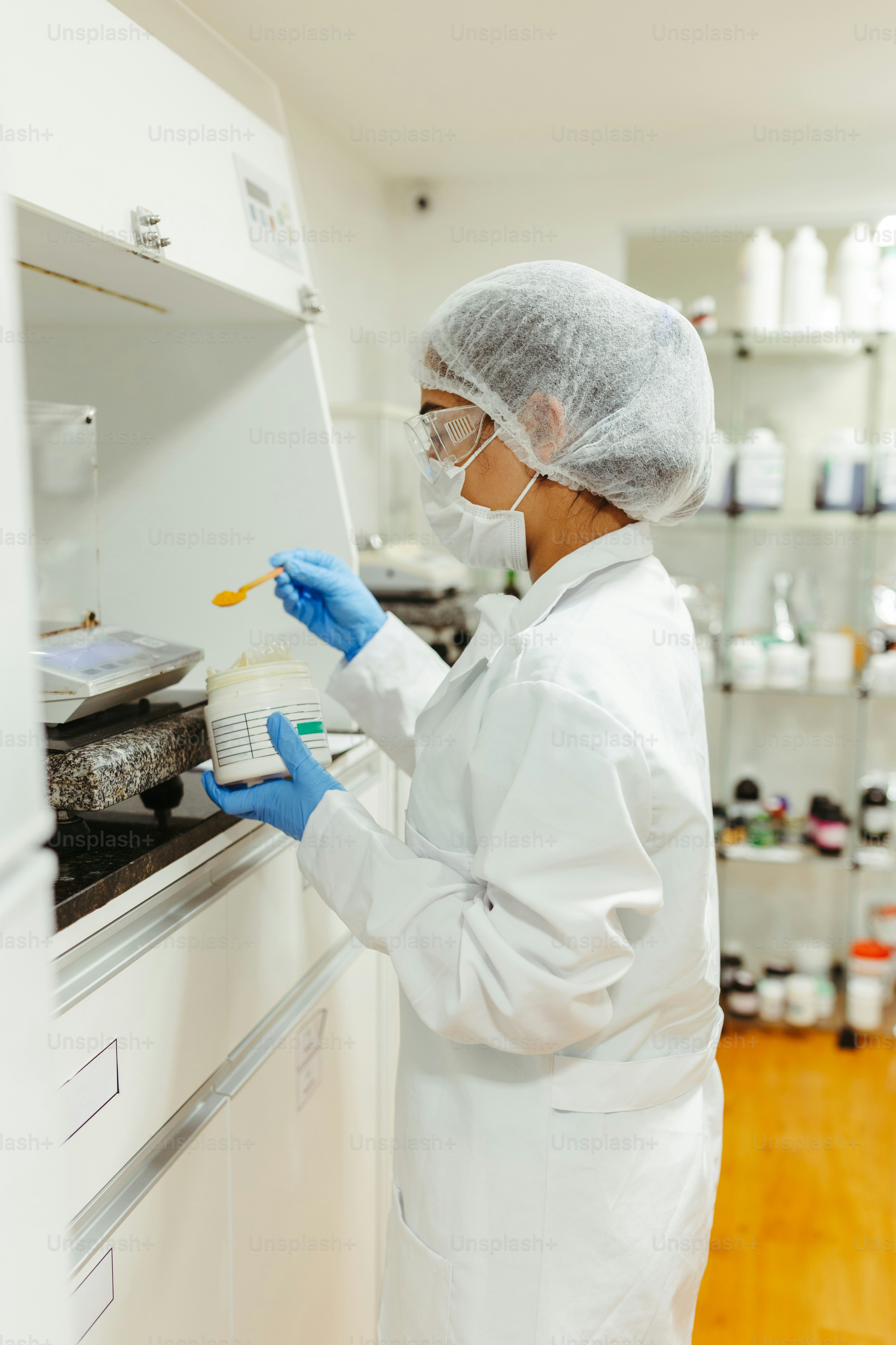 A woman in a lab wearing a mask and gloves photo – Scientists Image on ...