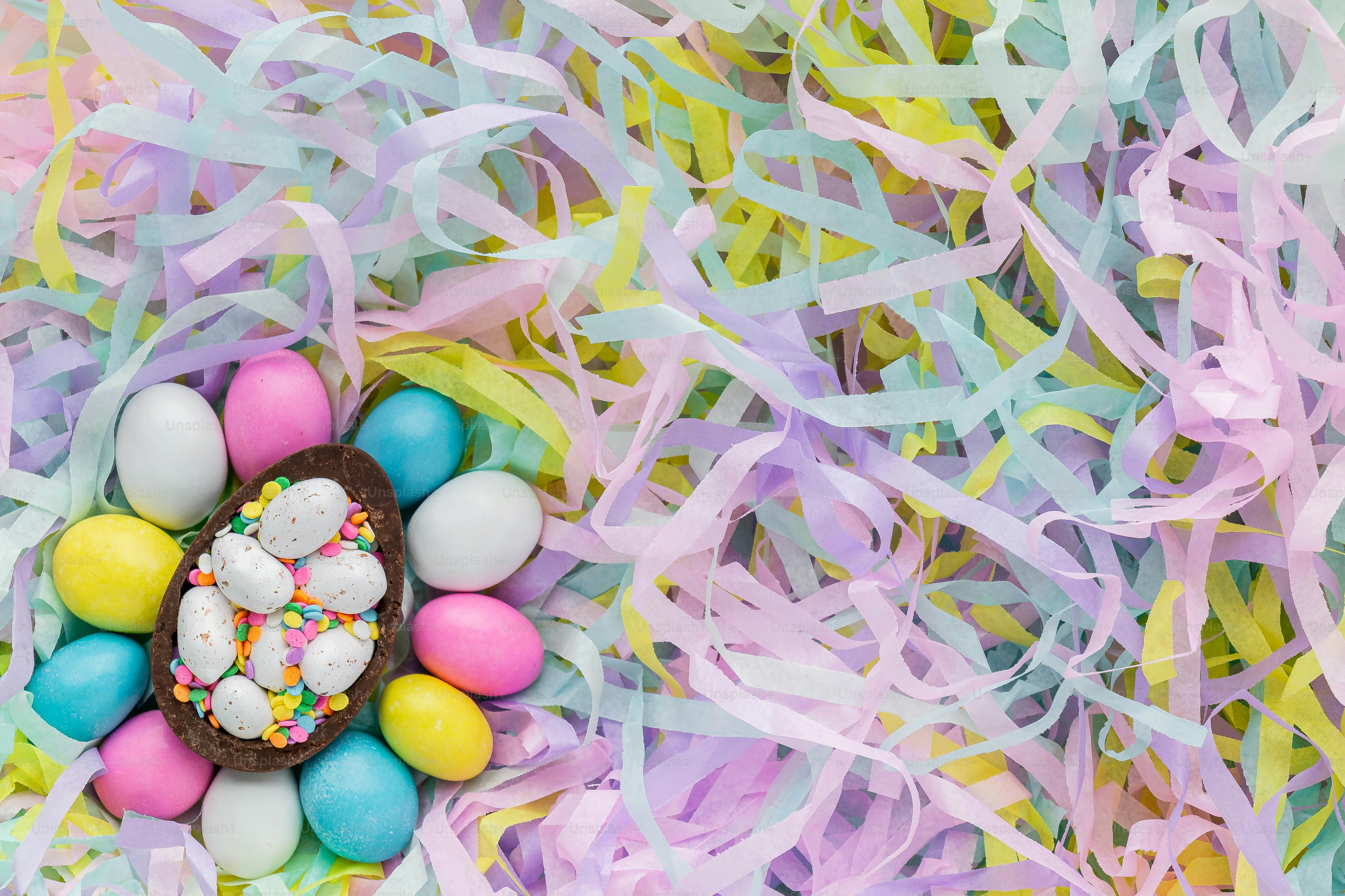 A chocolate egg surrounded by easter eggs and sprinkles photo – Easter ...