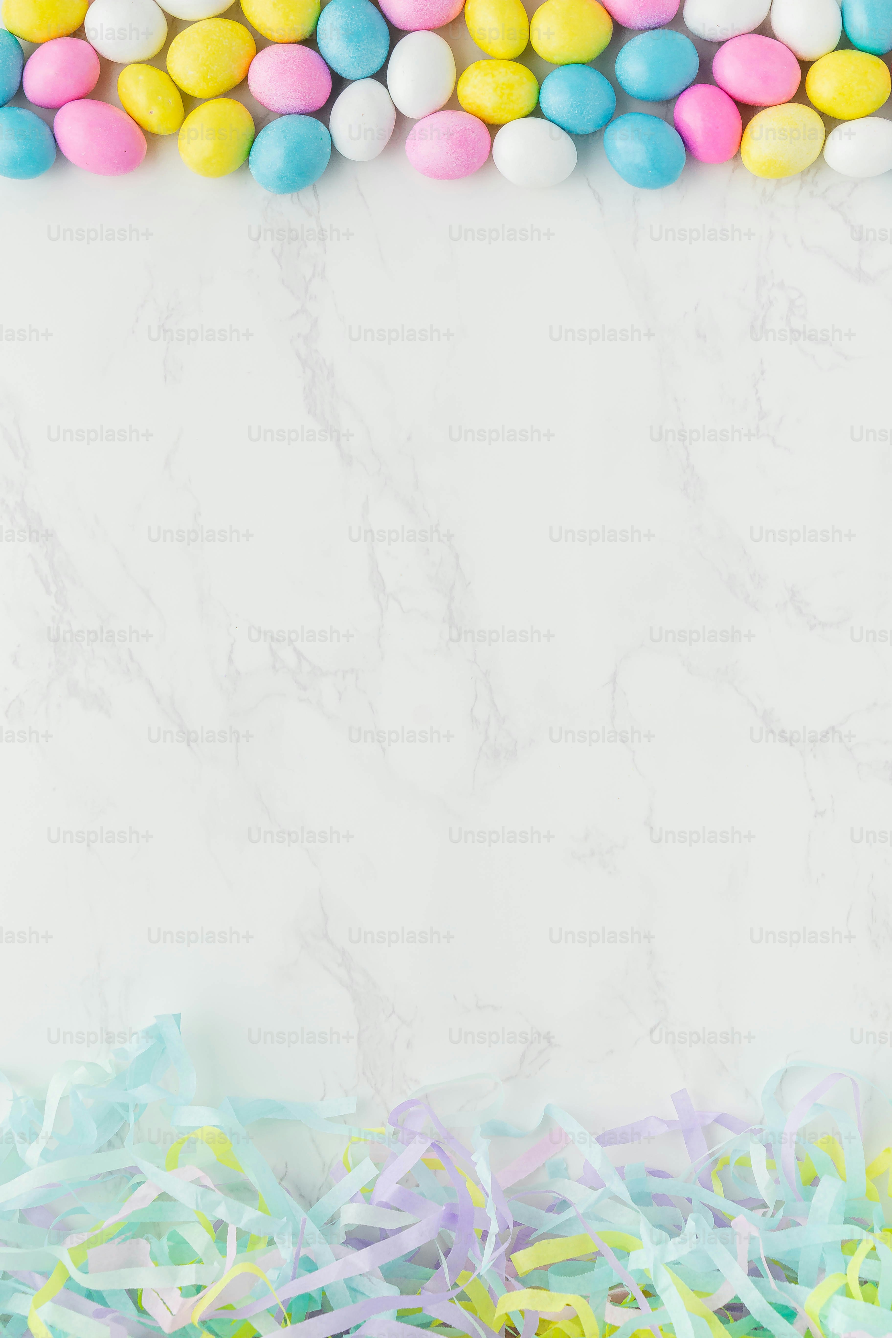 A marble background with colorful candies and streamers photo – Easter ...
