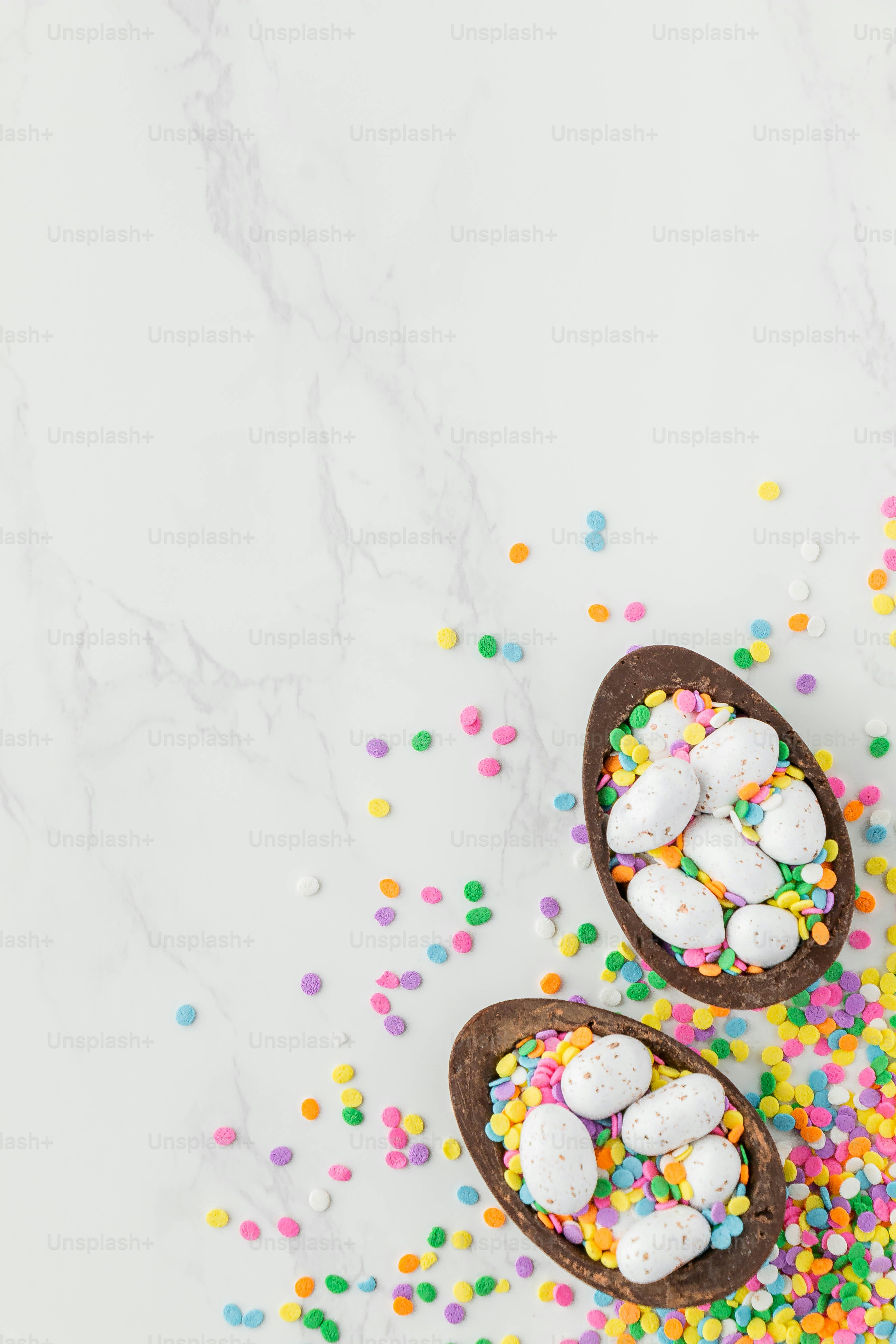 A table topped with chocolate easter eggs covered in sprinkles photo ...
