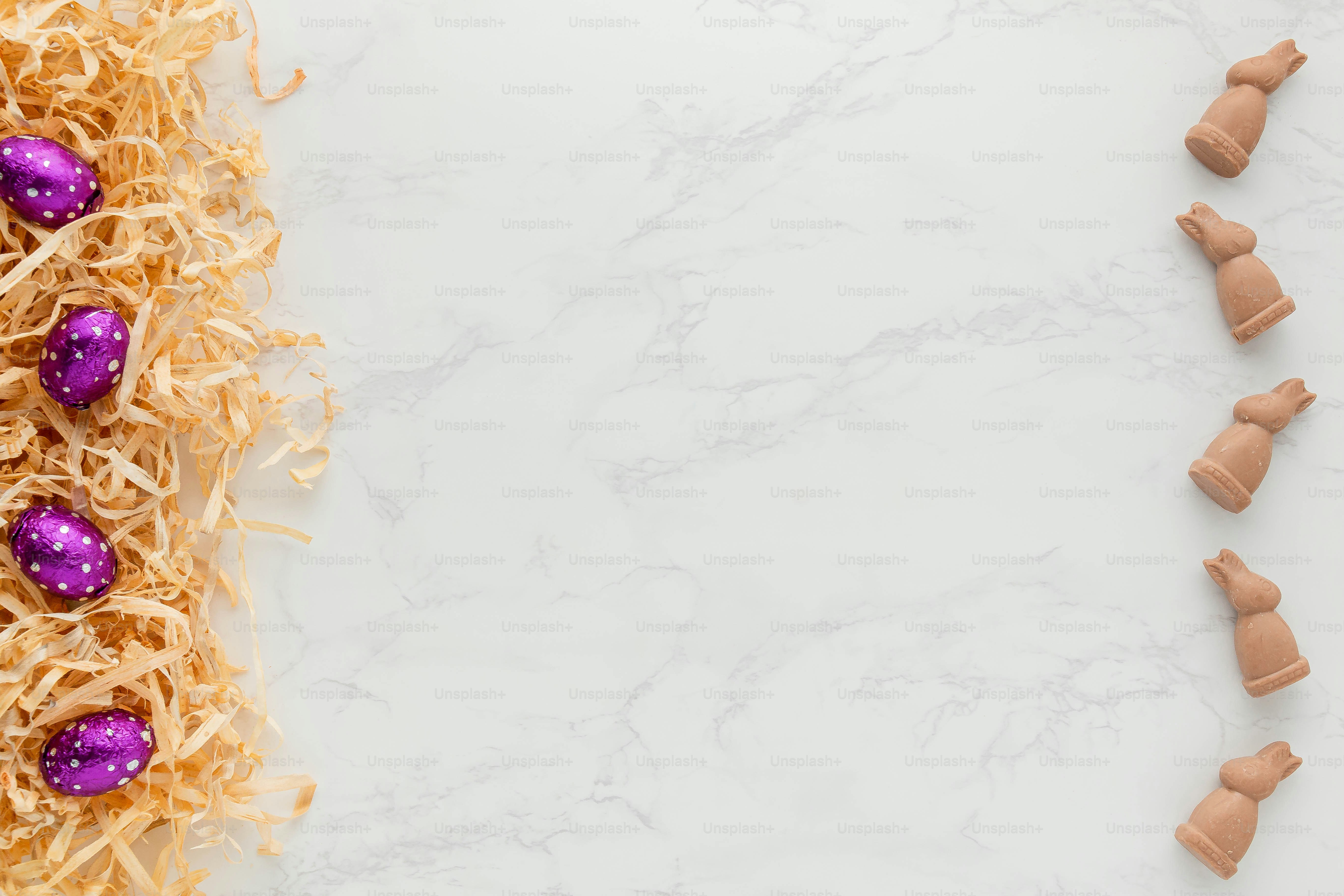 A pile of shredded hay next to some chocolate candies photo – Easter ...