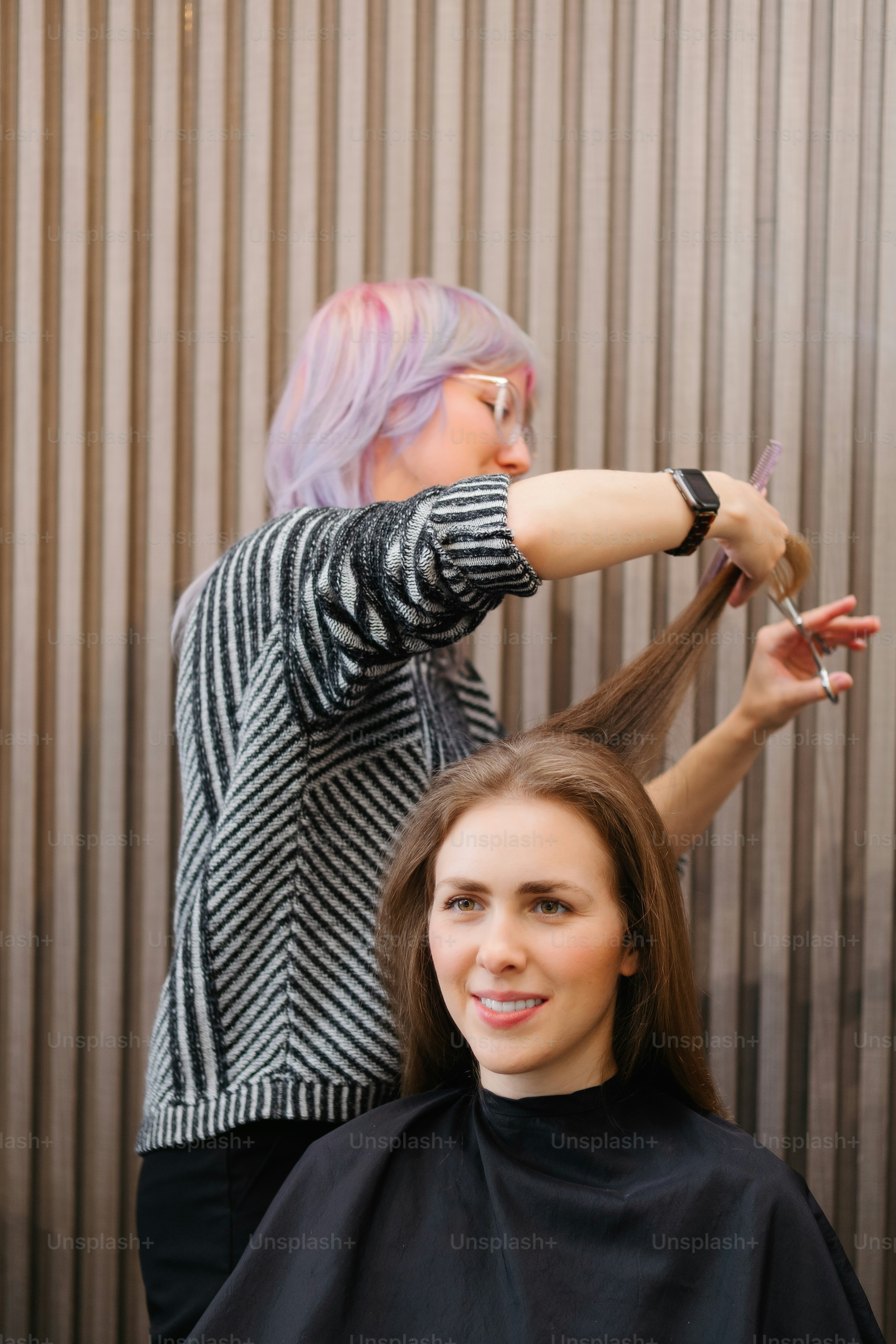 A woman getting her hair cut by a hair stylist photo – Stylist Image on ...