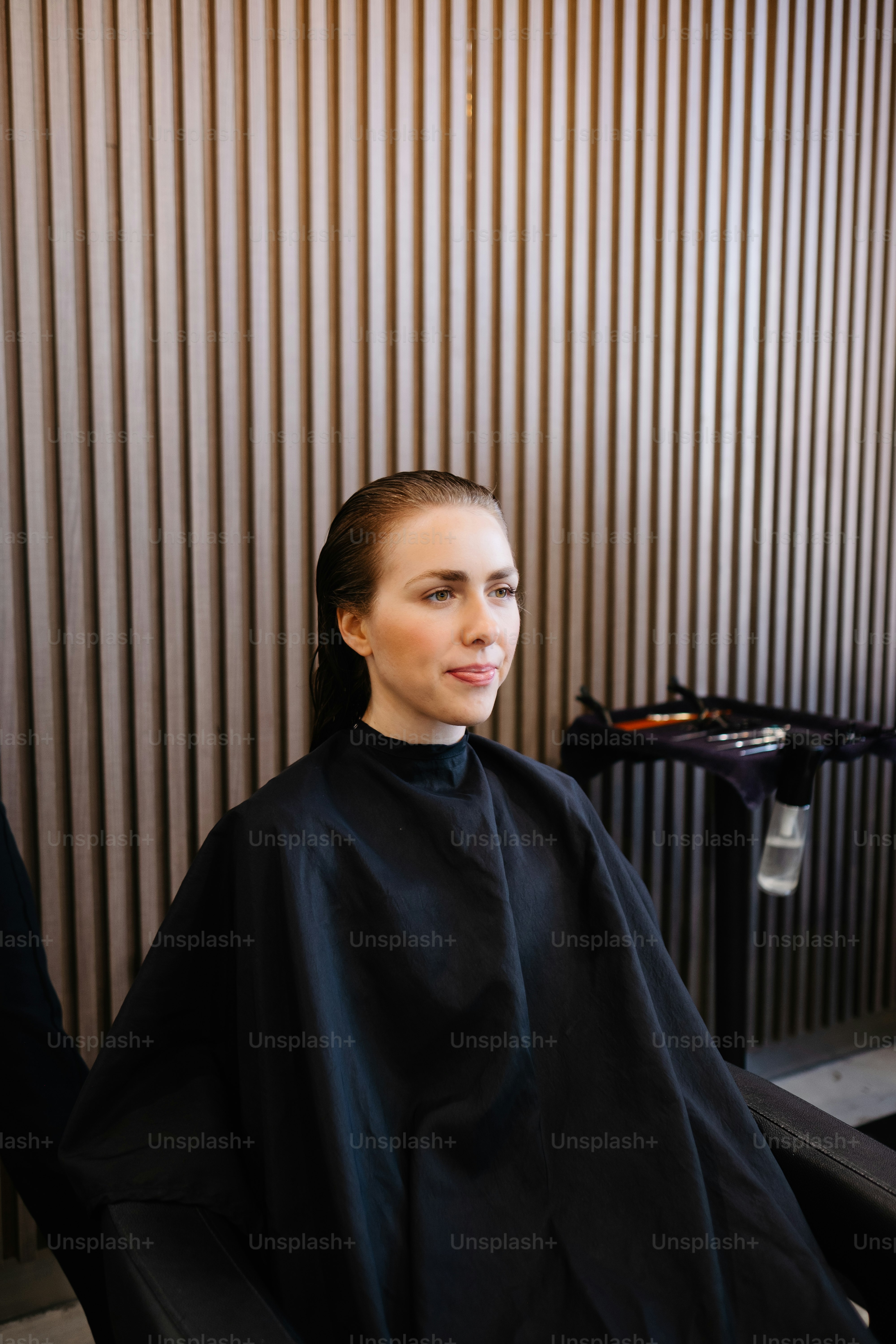 A woman cutting another woman's hair with a pair of scissors photo ...