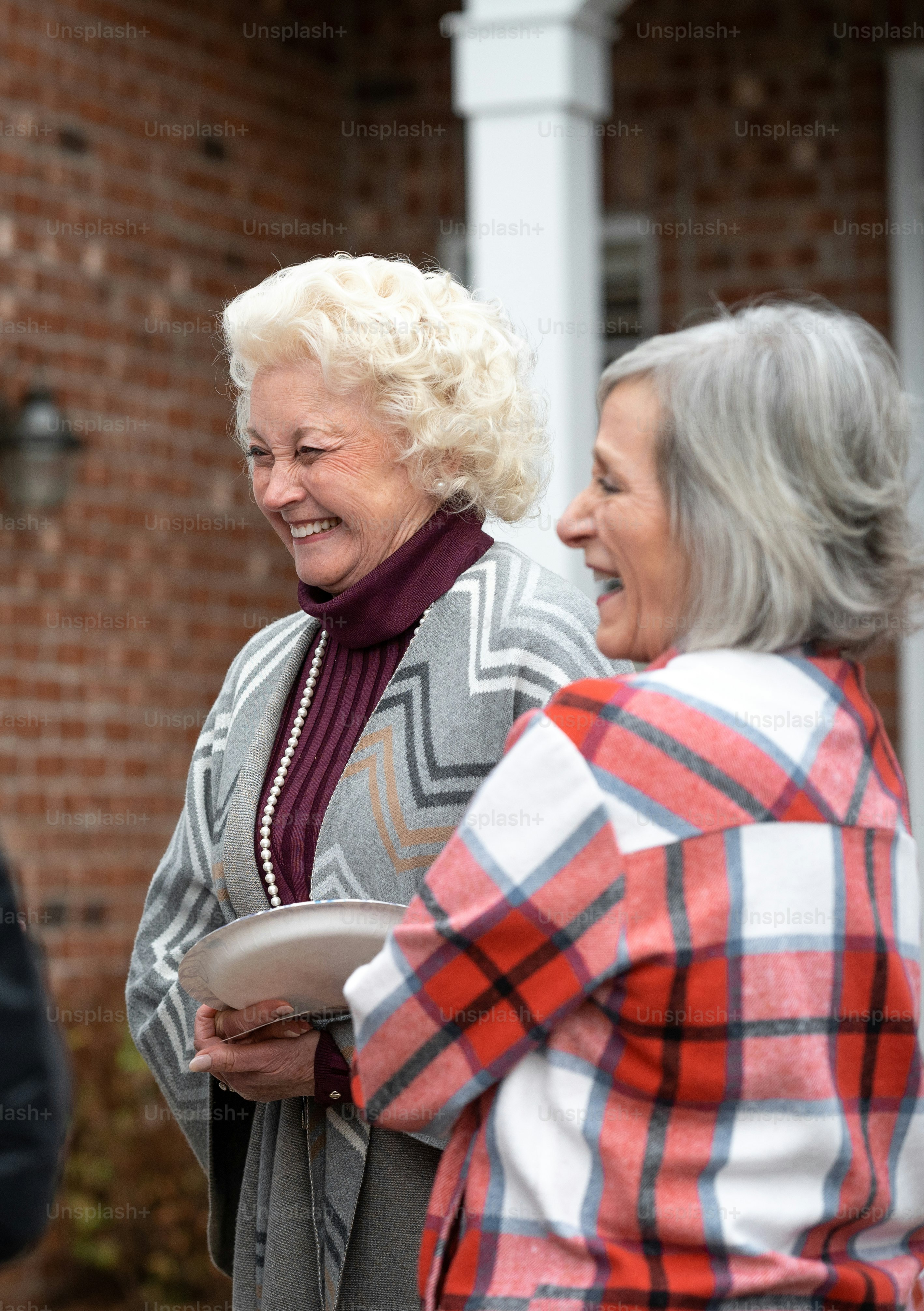Two older women standing next to each other photo – Retirement Image on ...