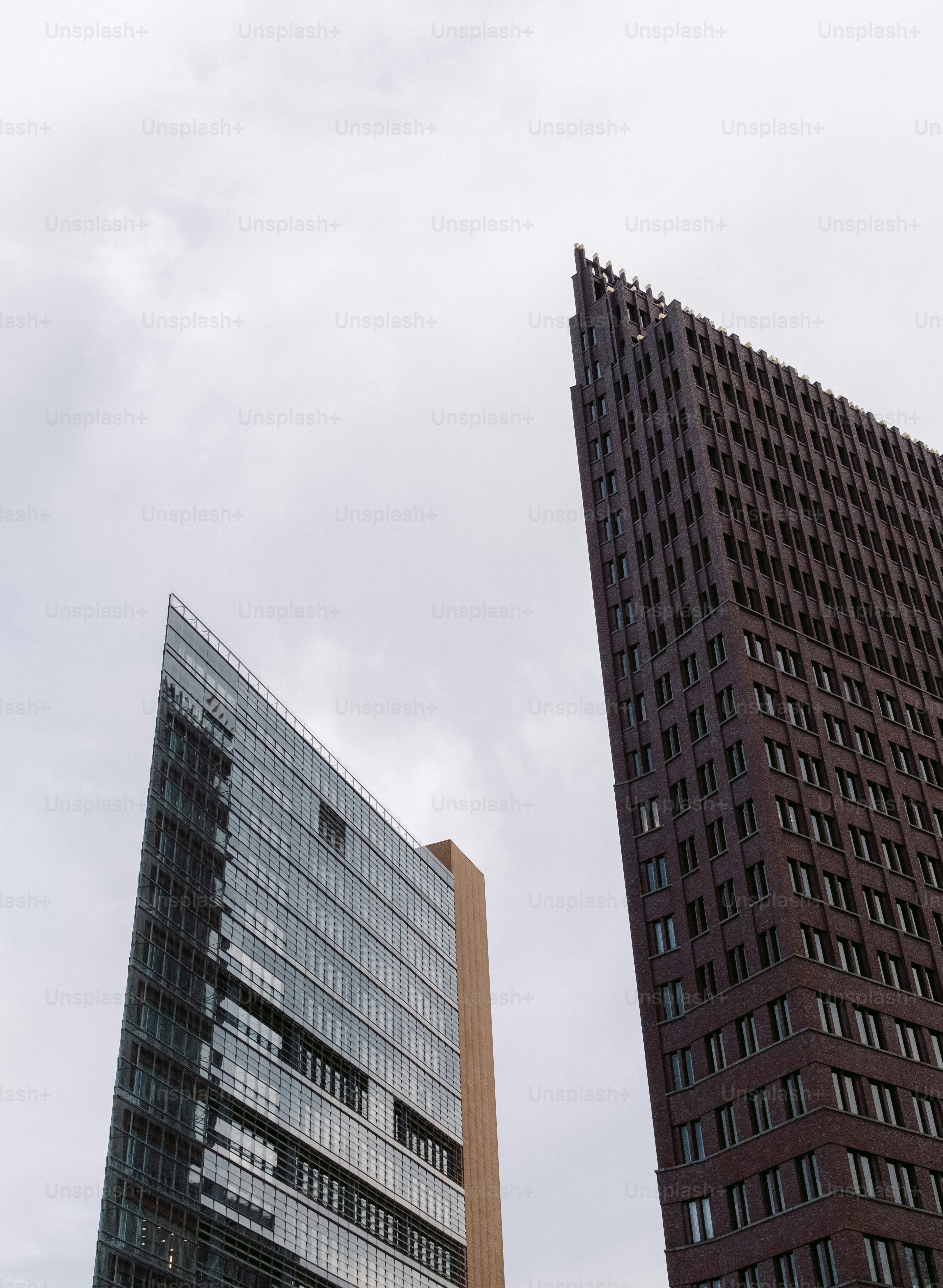 A couple of tall buildings sitting next to each other photo – Outside ...