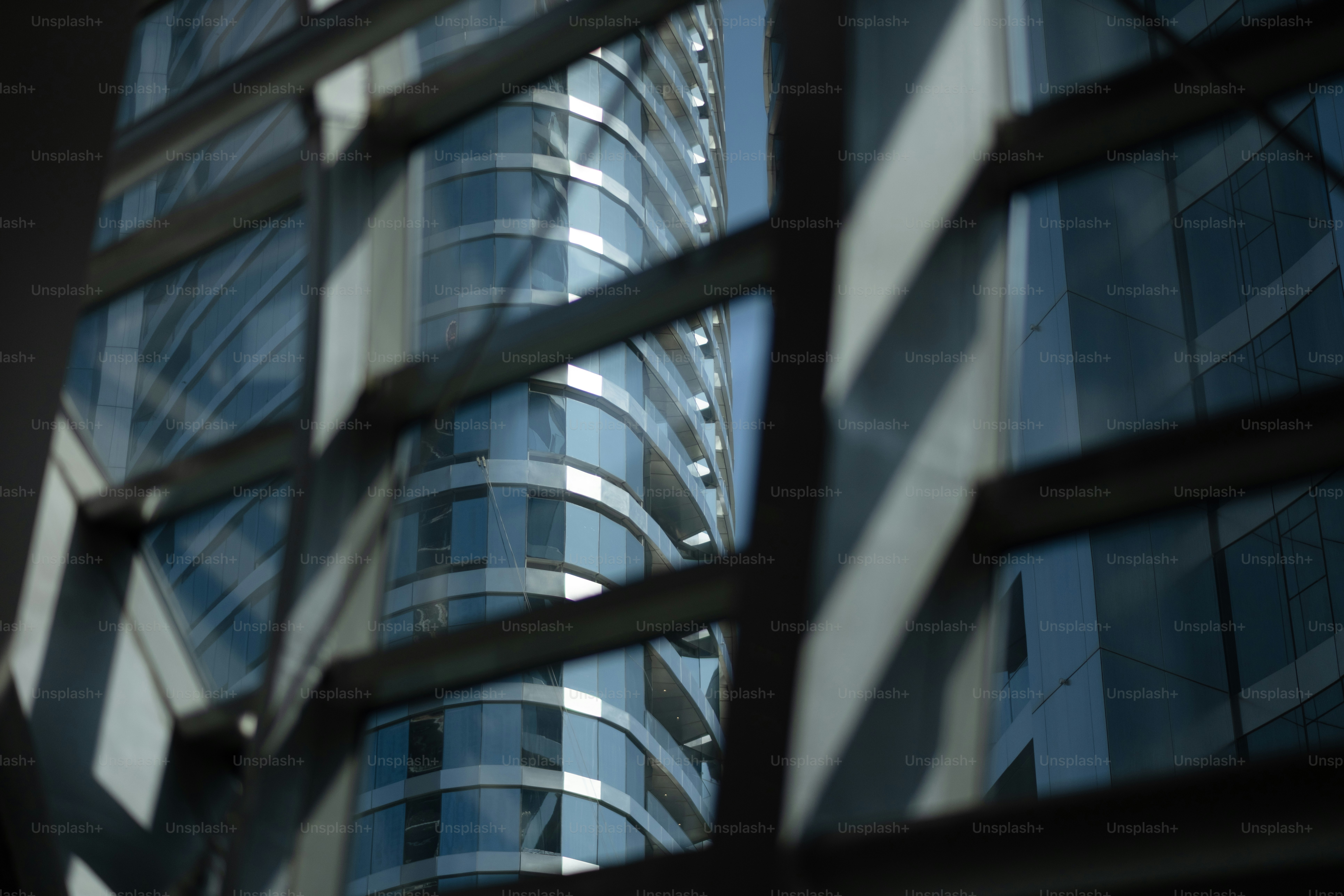 A very tall building with lots of windows photo – Glass facade Image on ...