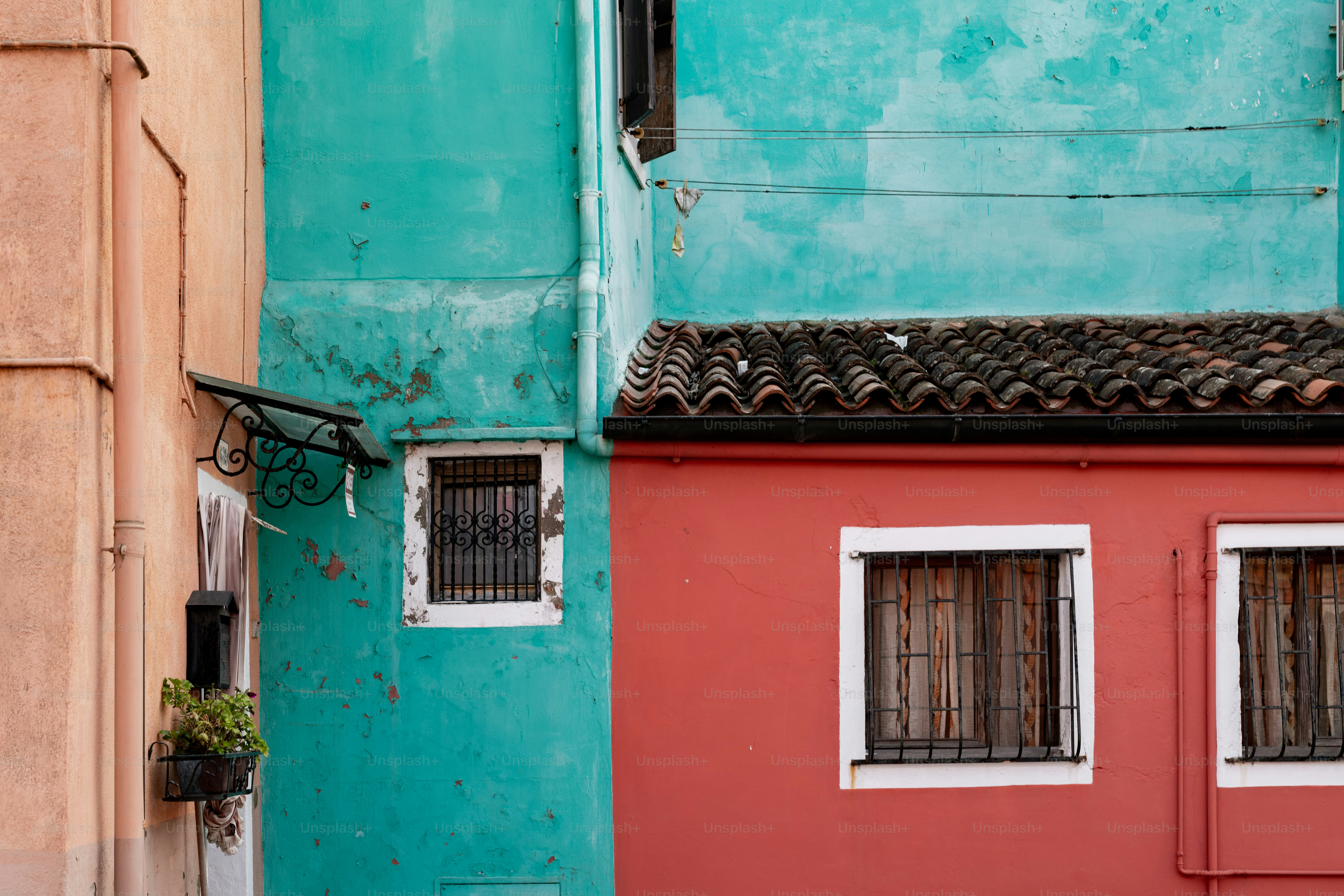 A blue building with a clock on the top of it photo – Italy Image on ...